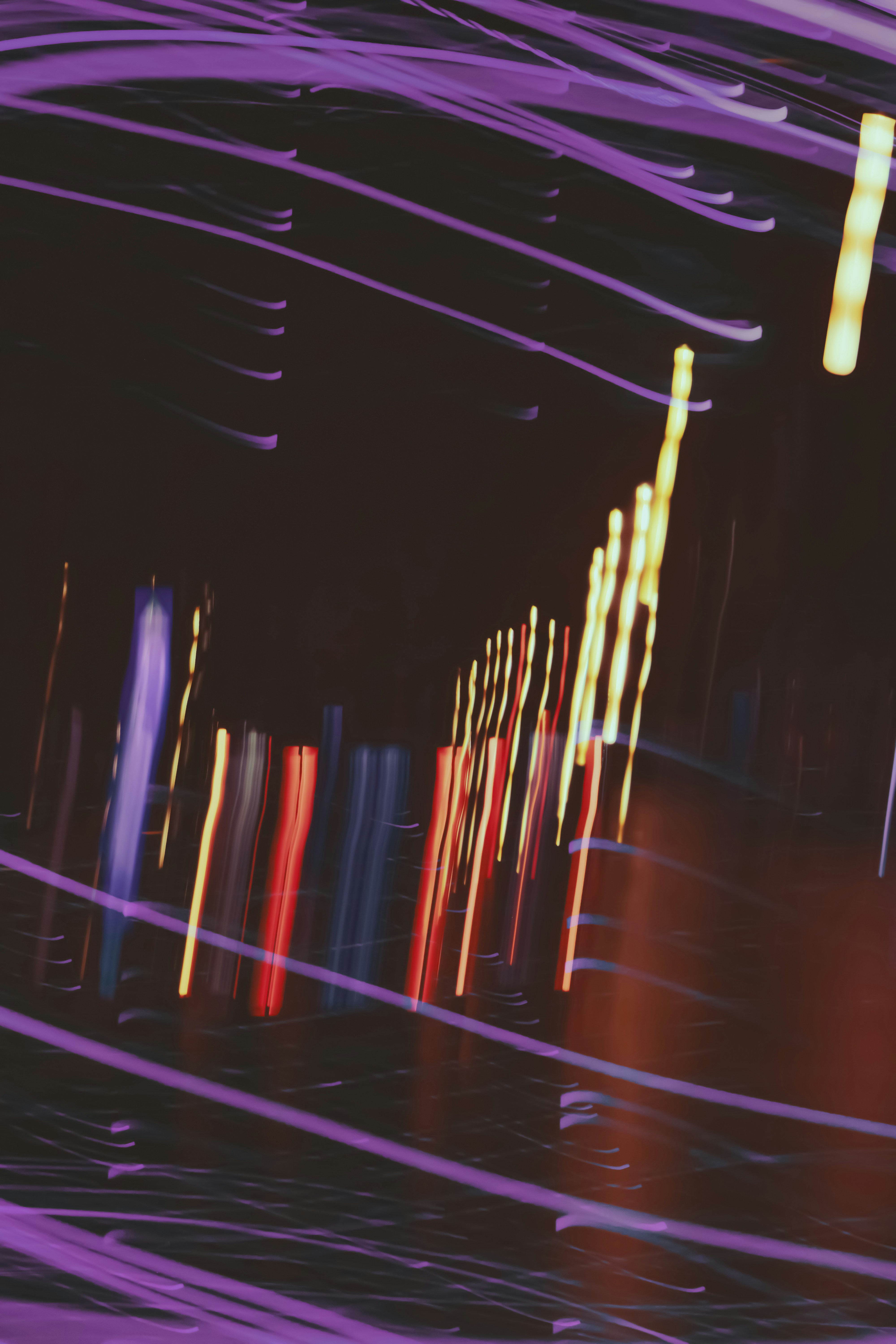 Neon Whirl: Concentric Streaks Through a Night Tunnel