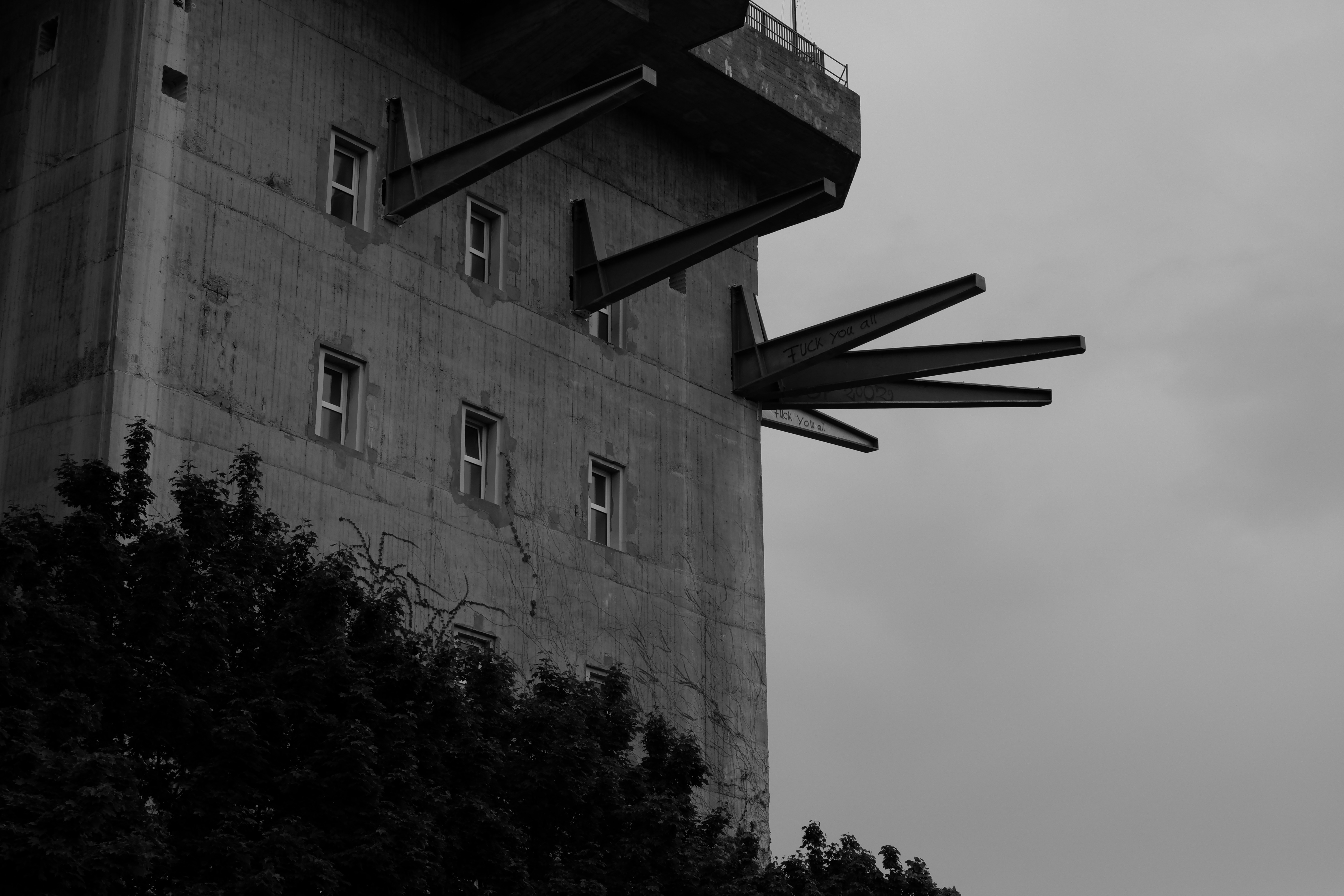 Concrete Monolith with Spoked Extensions Against a Silenced Sky
