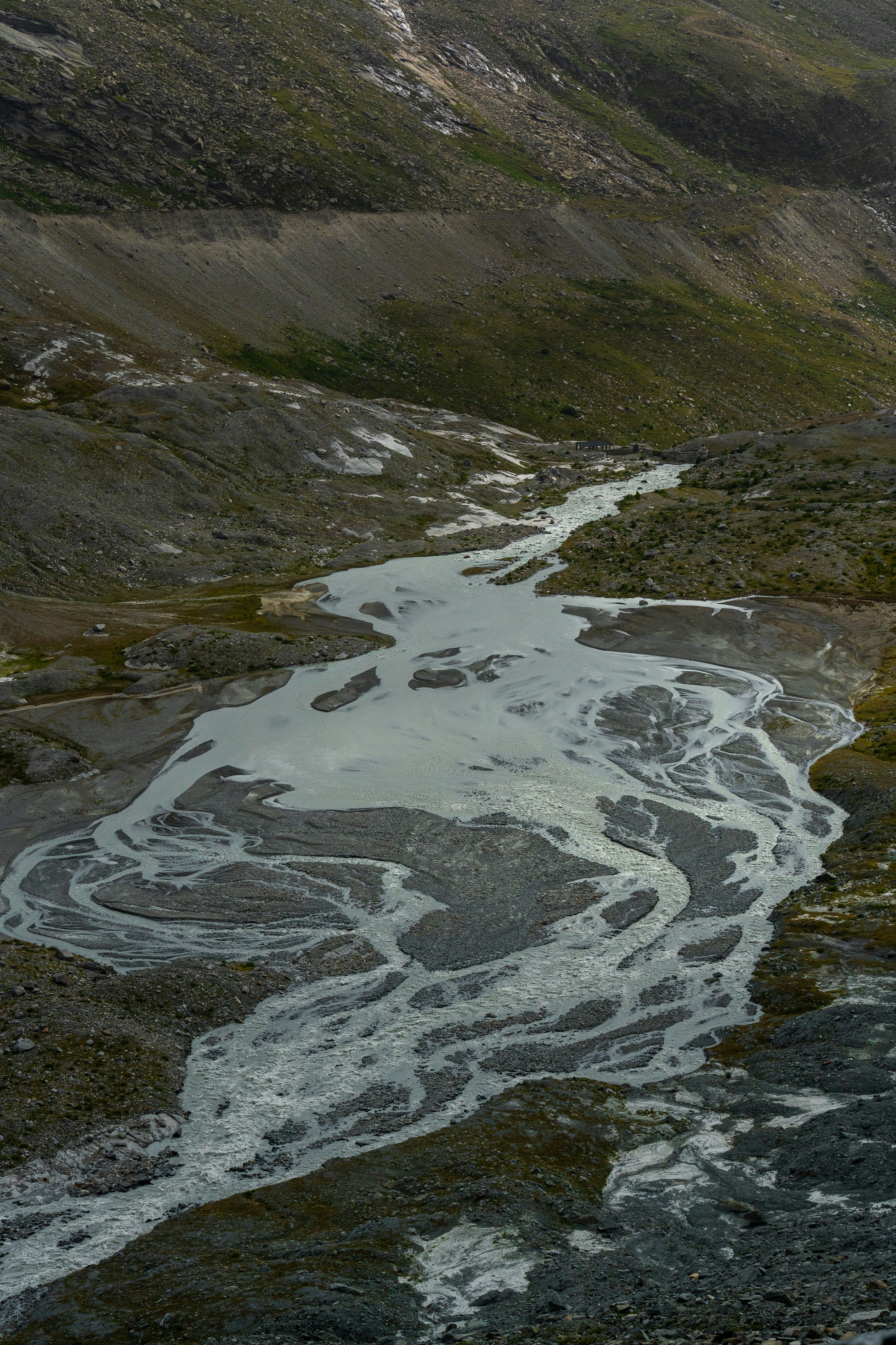 Bleached Vein of Icewater: A Mountain Stream Winding Through Slate Valleys