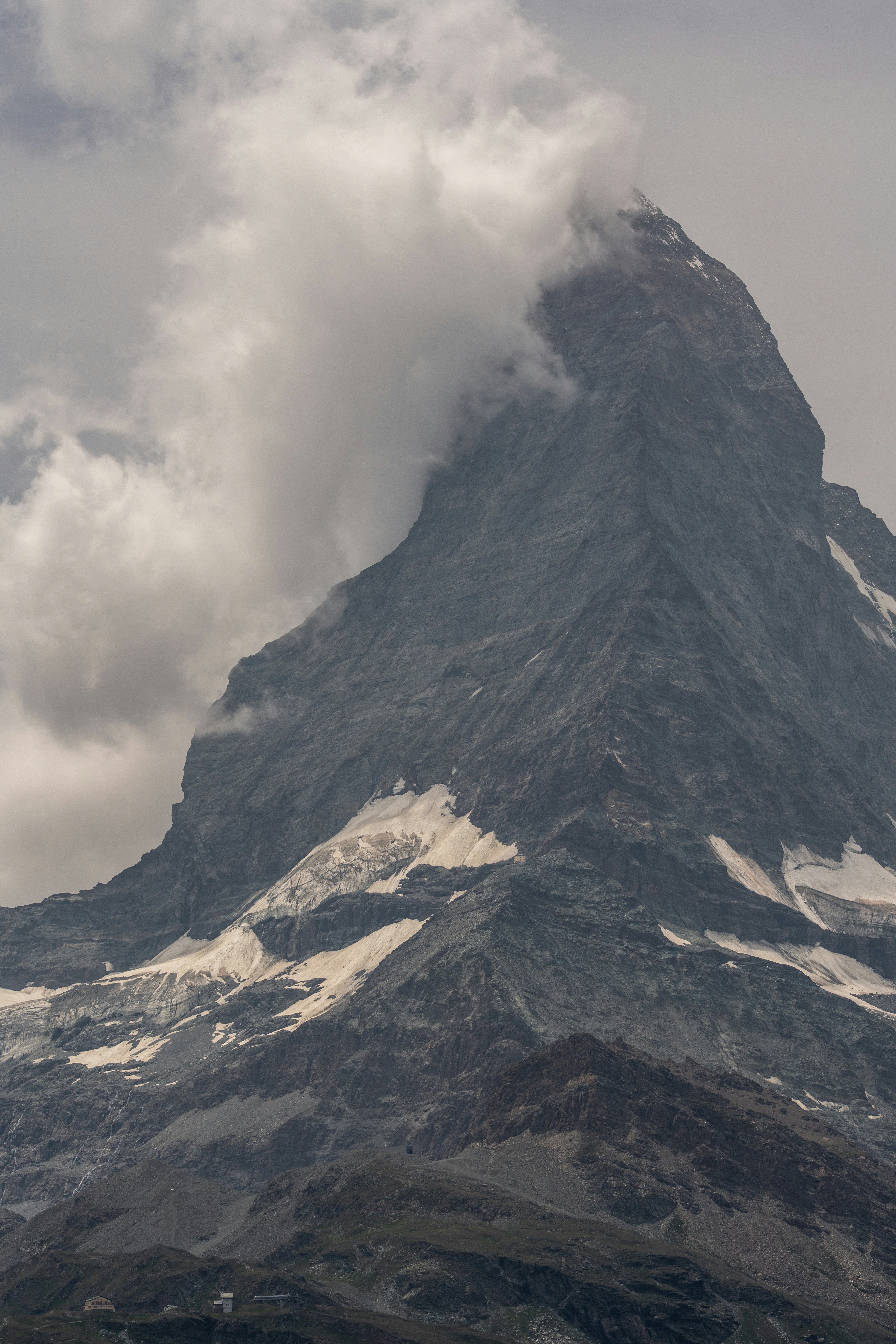The Cloud-Wedged Summit: A Towering Peak Emerges from the Mist