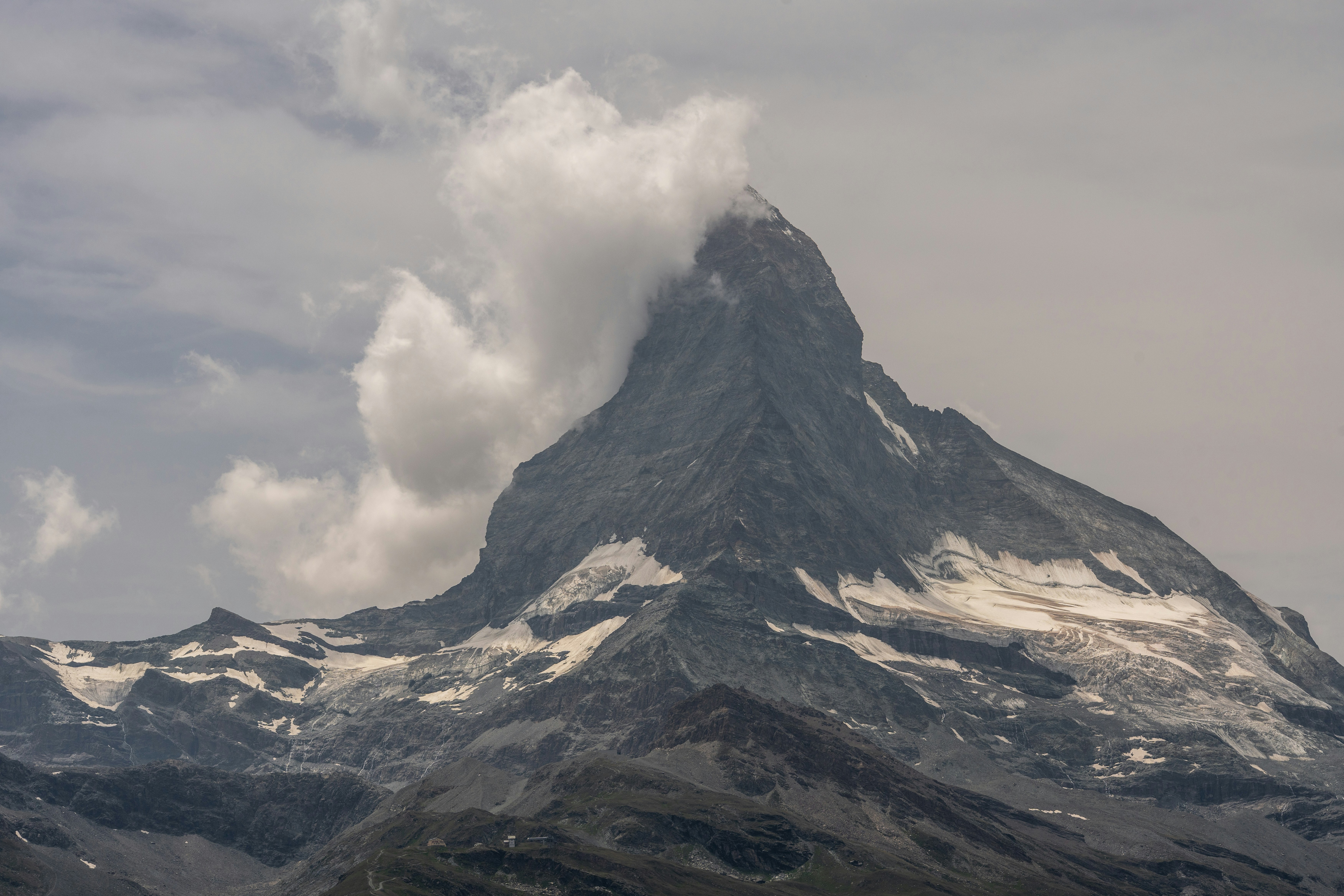 Peak in Perilous Weather: Cloud-Wreathed Matterhorn-like Summit