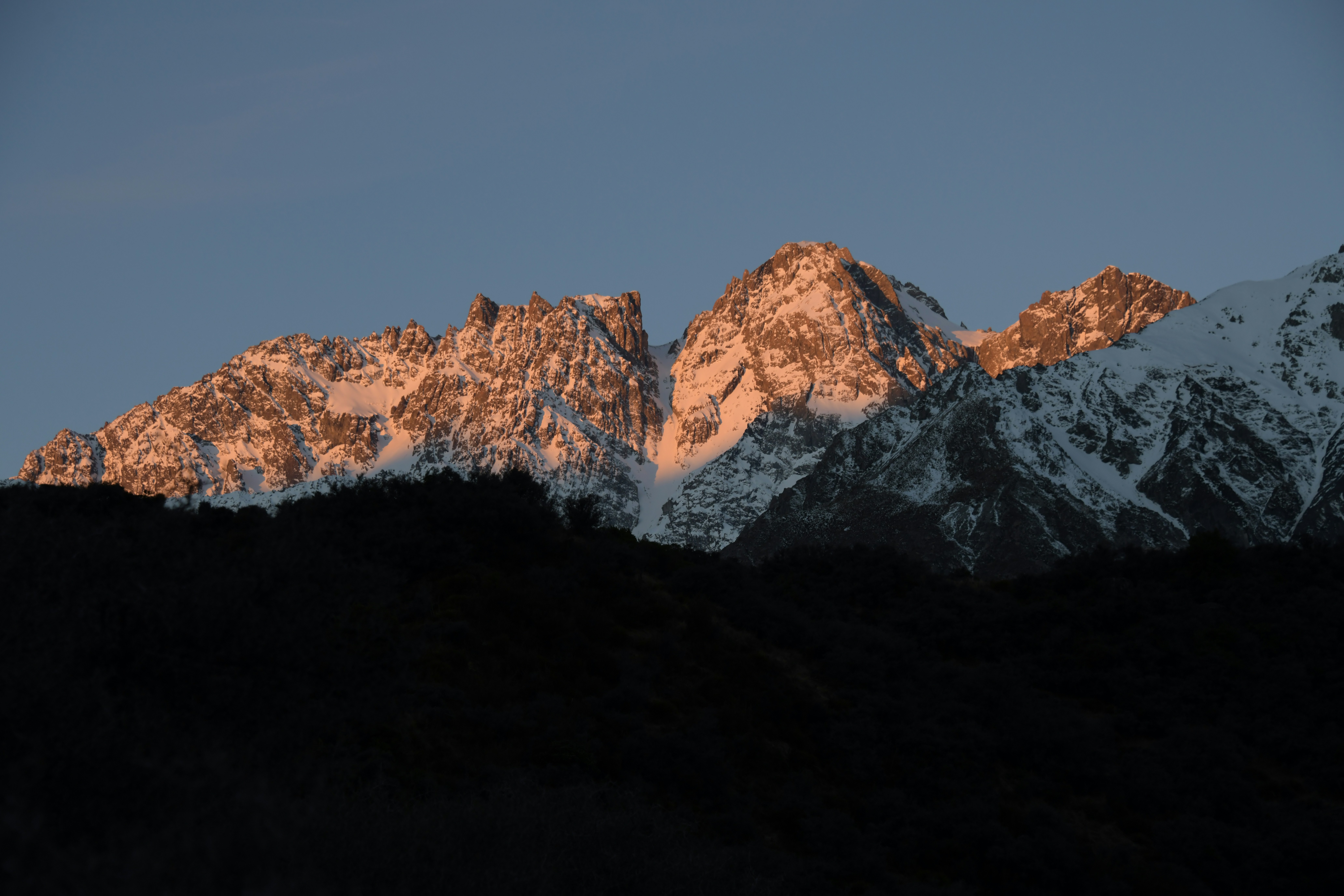 Tawny Peaks at Dusk: Snow-Capped Giants Edge the Twilight