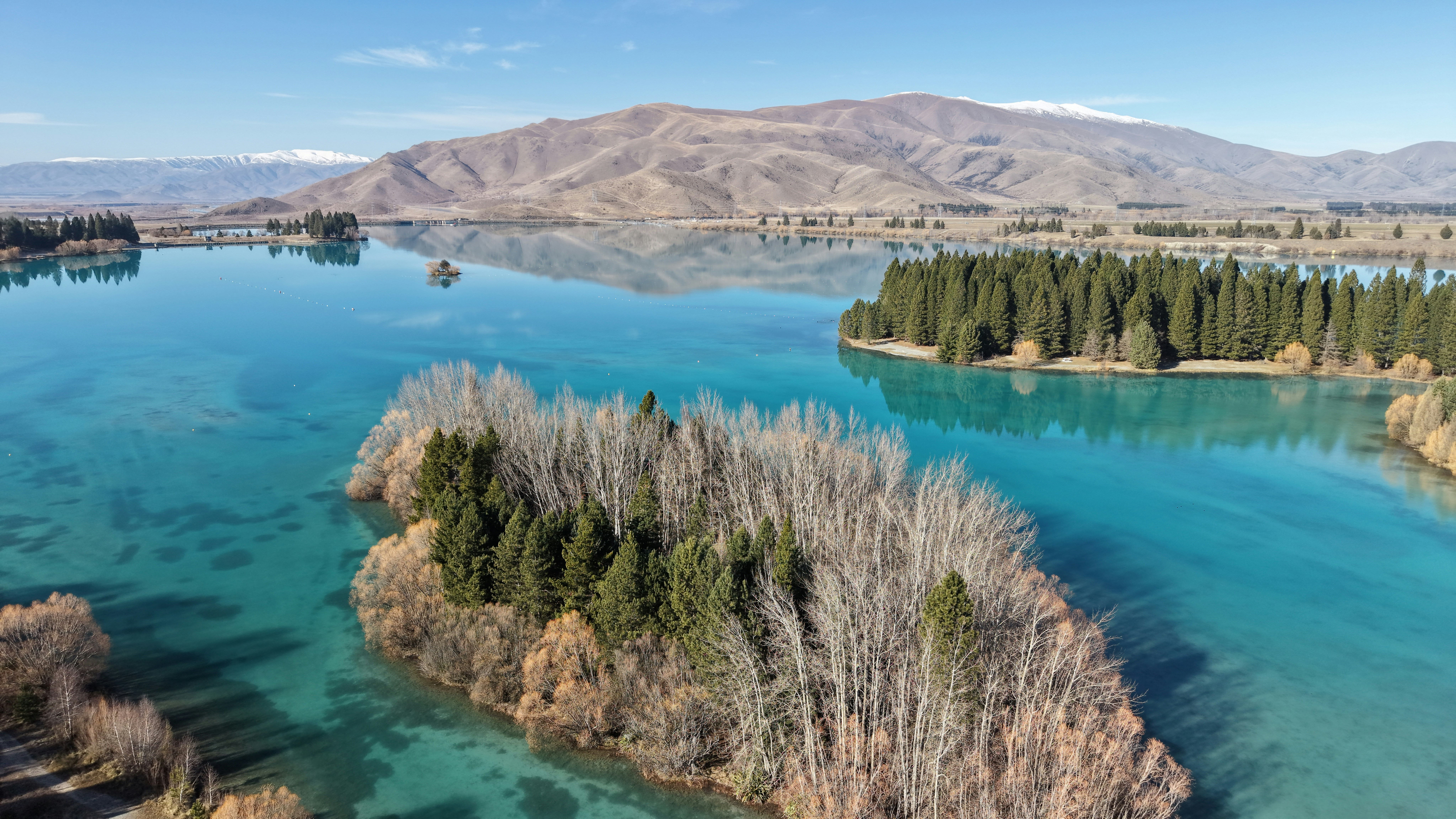 Serene turquoise inlet framed by distant mountains
