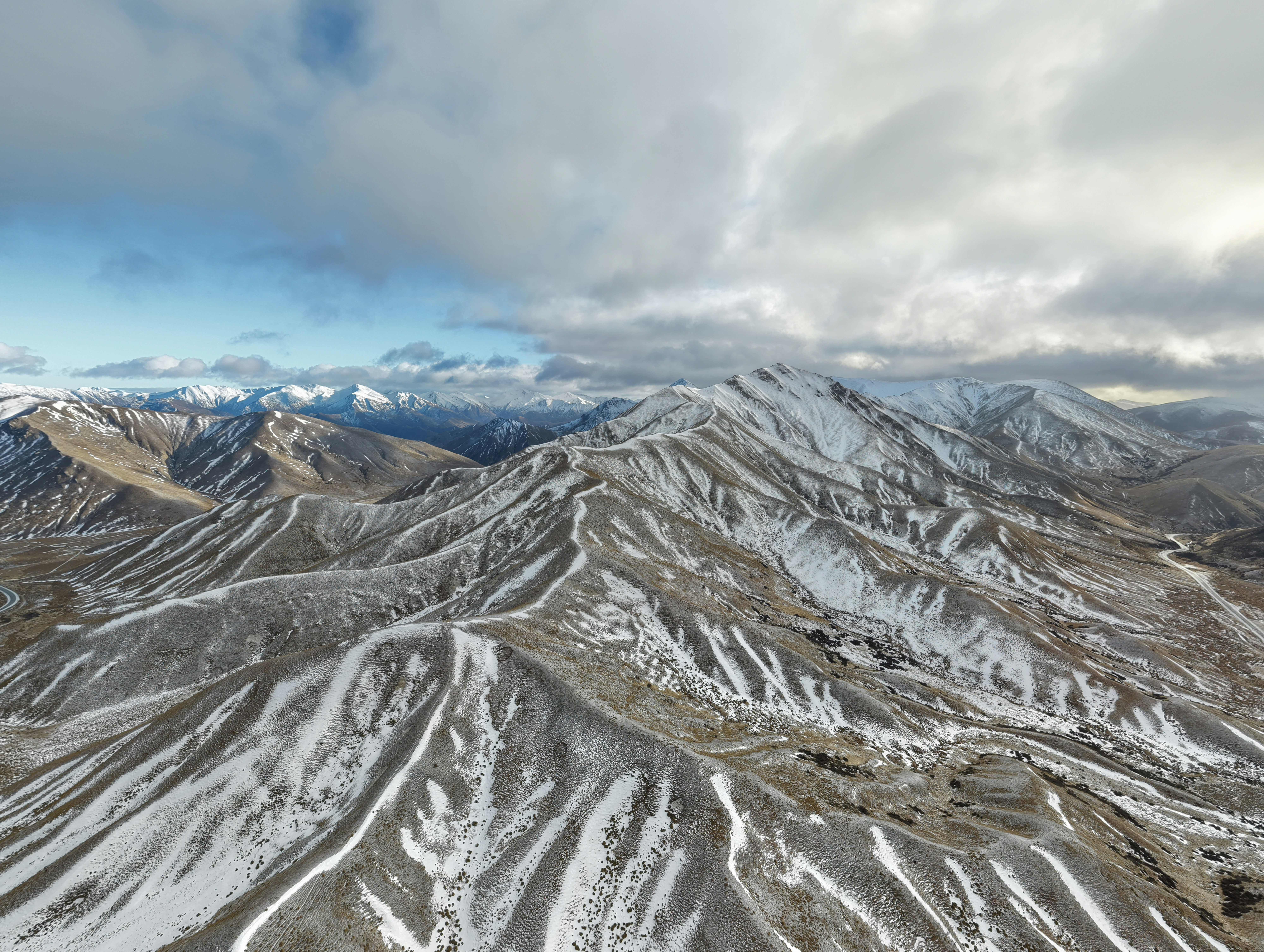 Snow-veined ridges under a brooding alpine sky