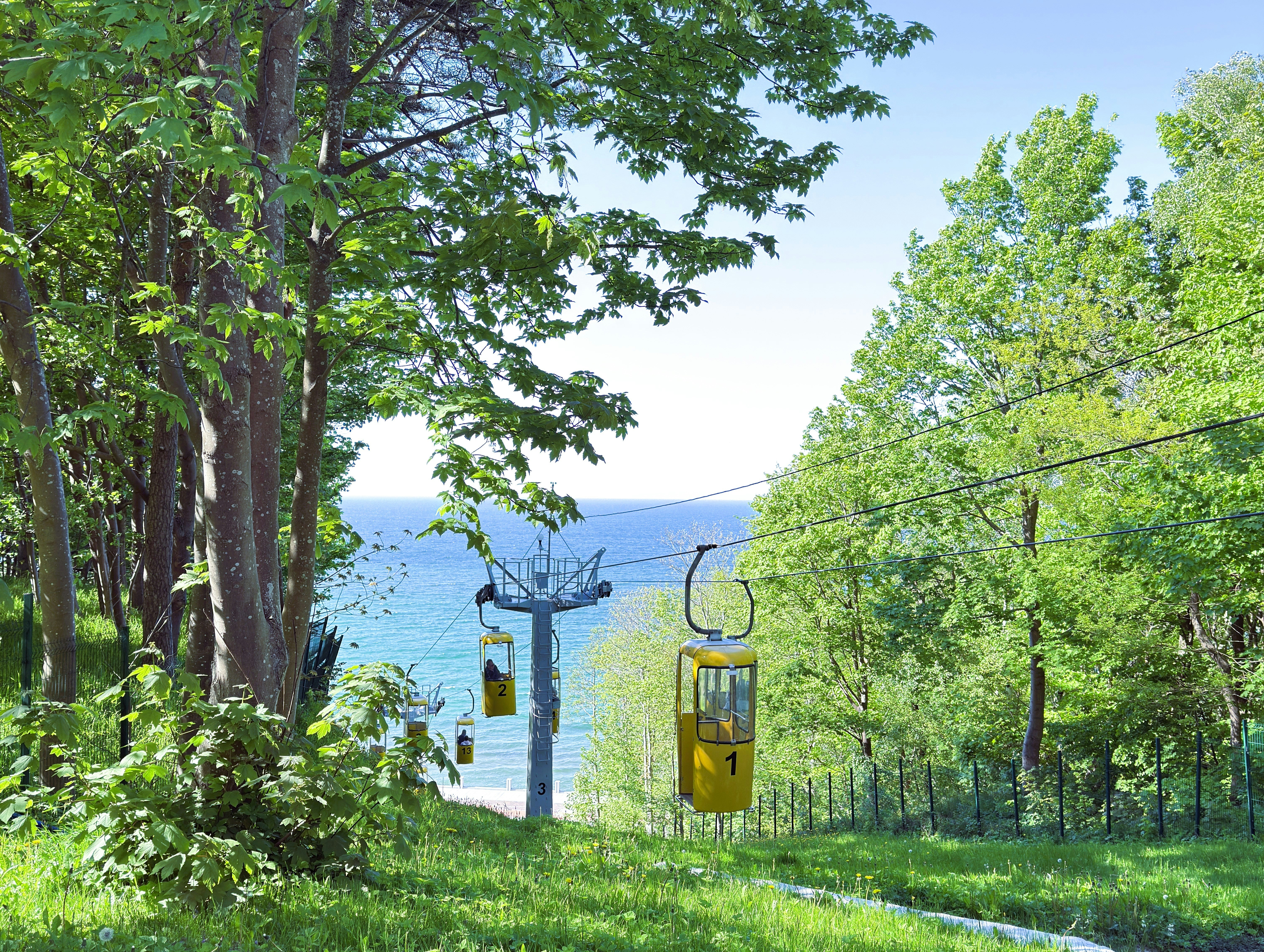 Yellow Chairlift Overlooking a Sunny Lake