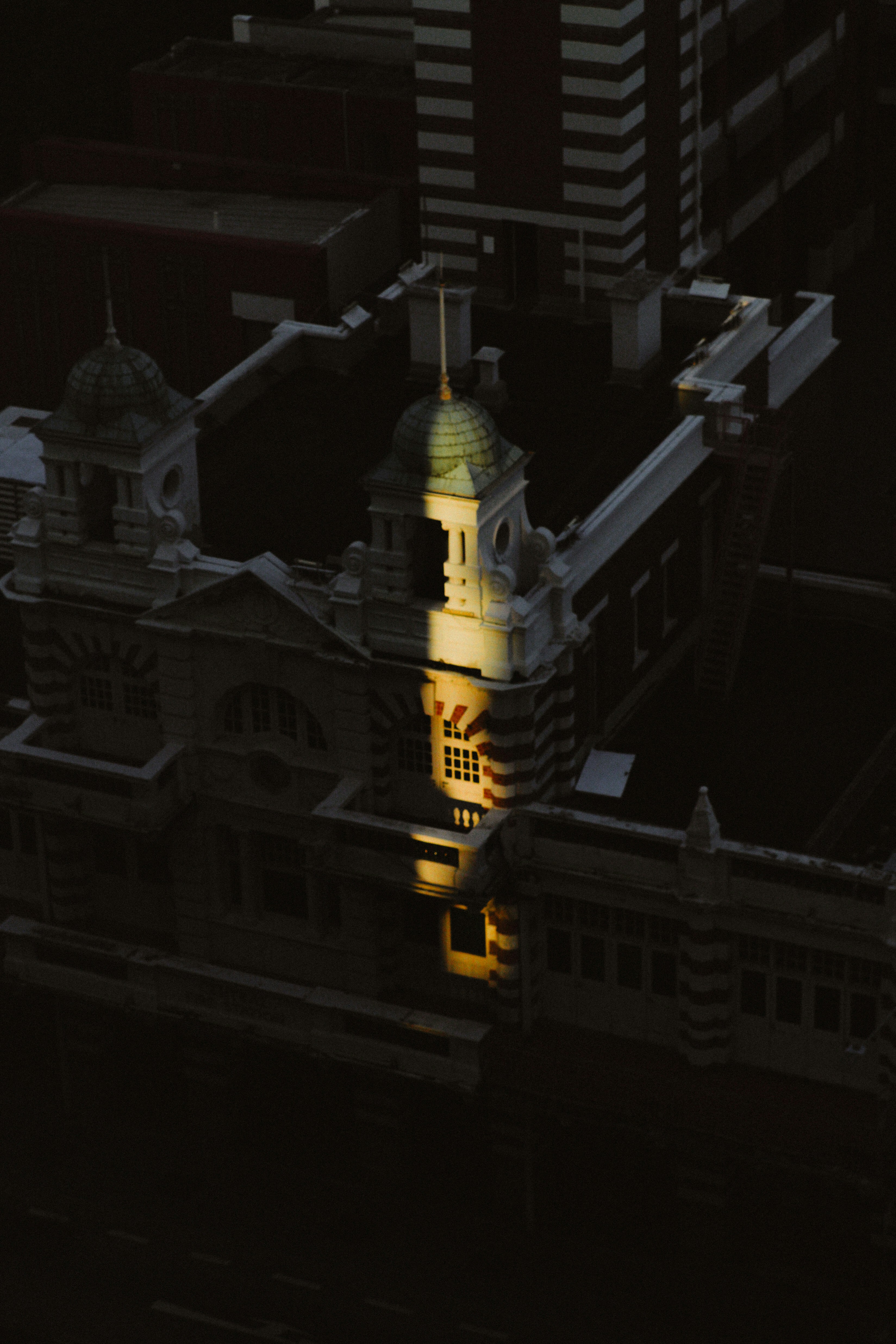 Sunlight illuminates a historic building at dusk.