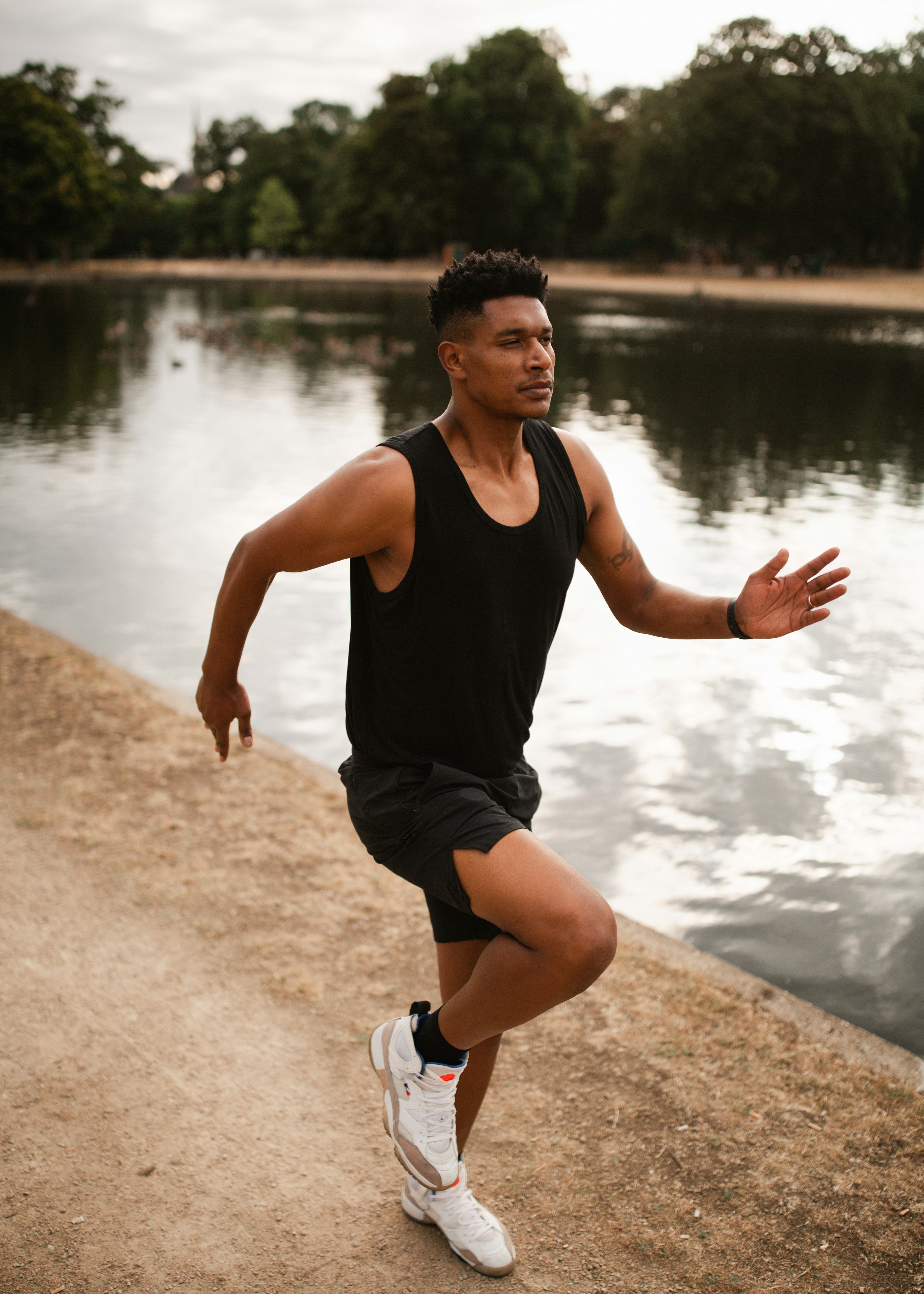 Runner Along the Riverbank: A Moment of Athletic Focus