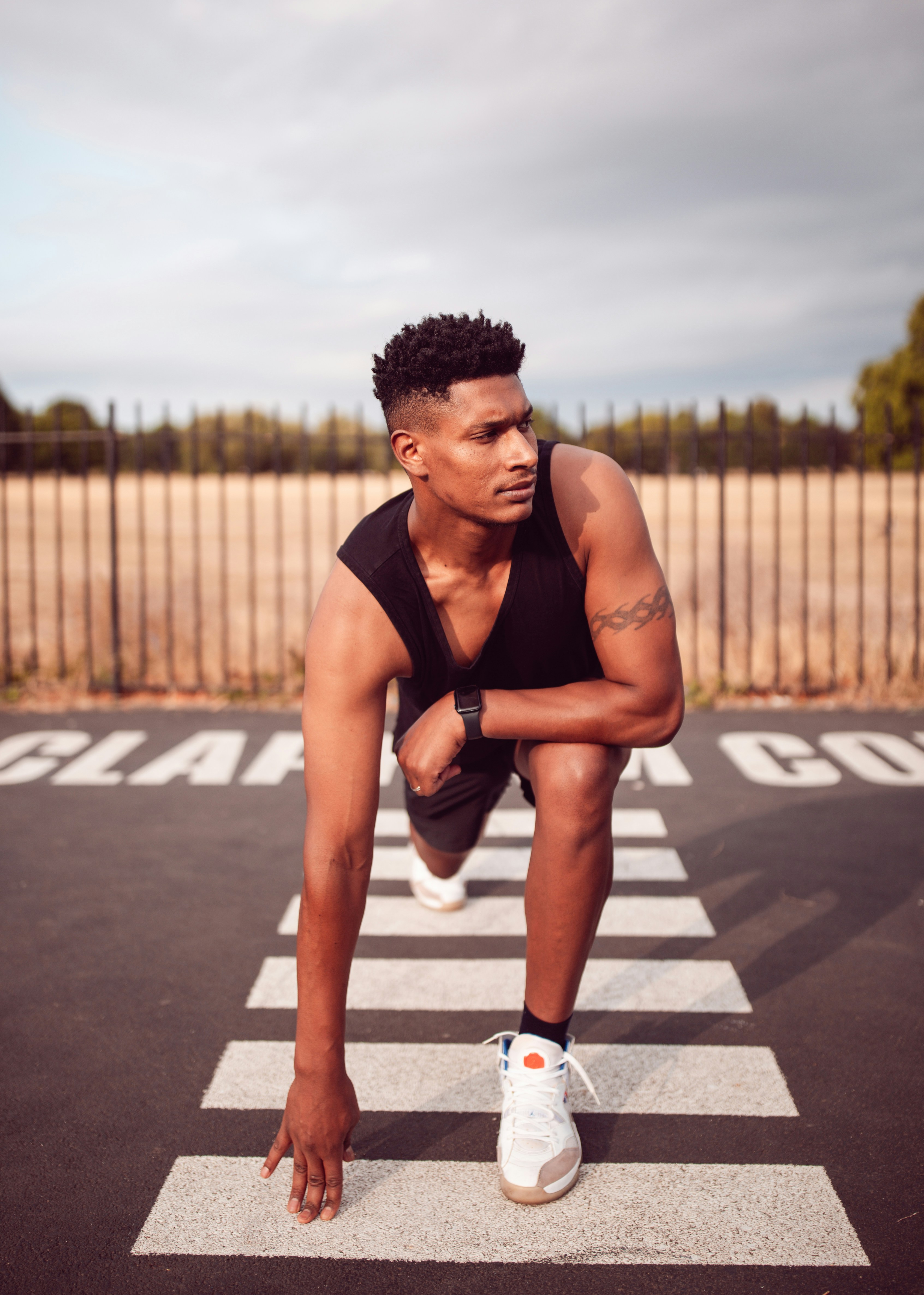 Starting Lineup: poised runner at the edge of the lane