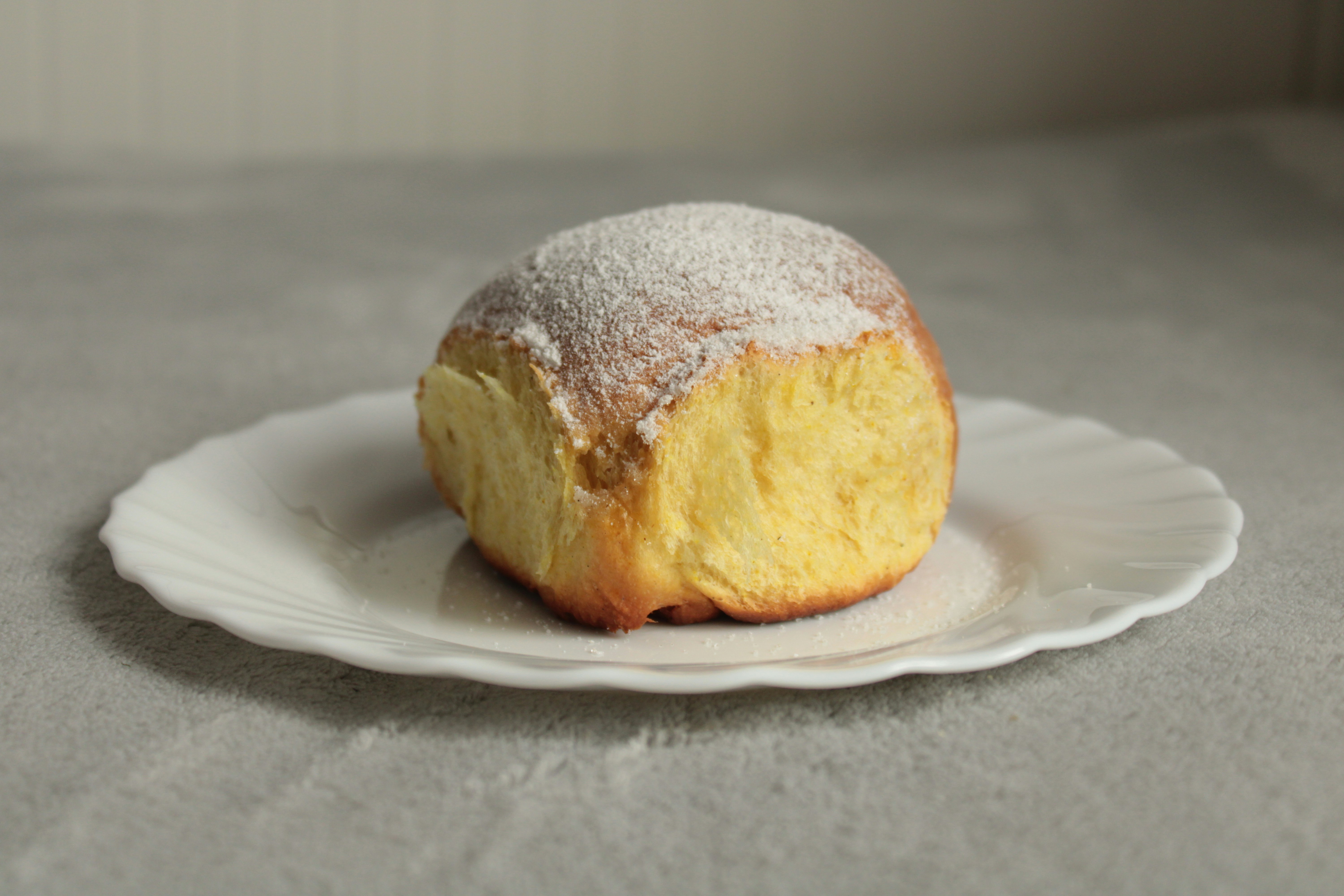 Powdered Golden Roll on a Quiet Plate