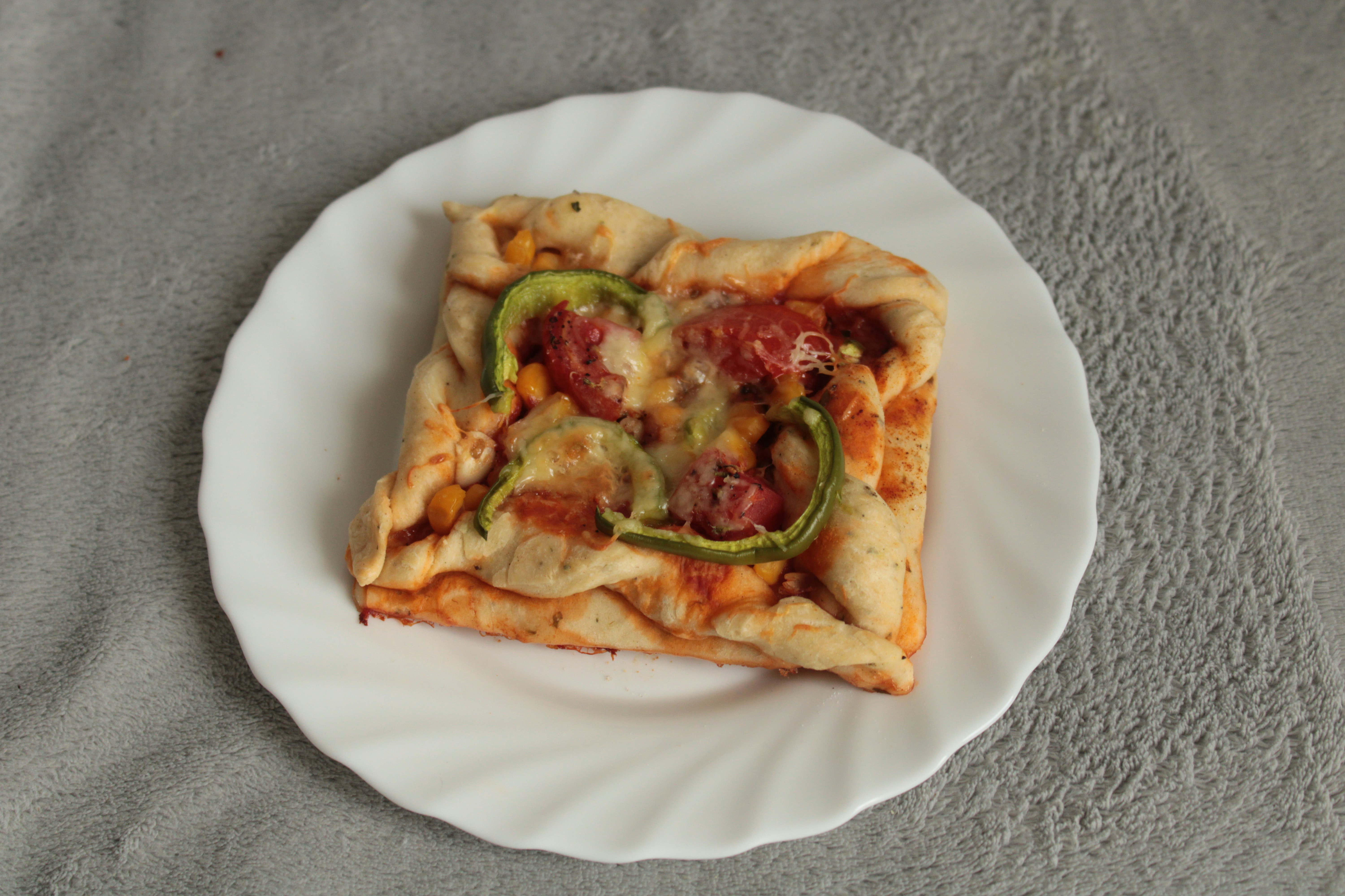 Slice of Comfort: Pepperoni and Pepper Pizza on a White Plate