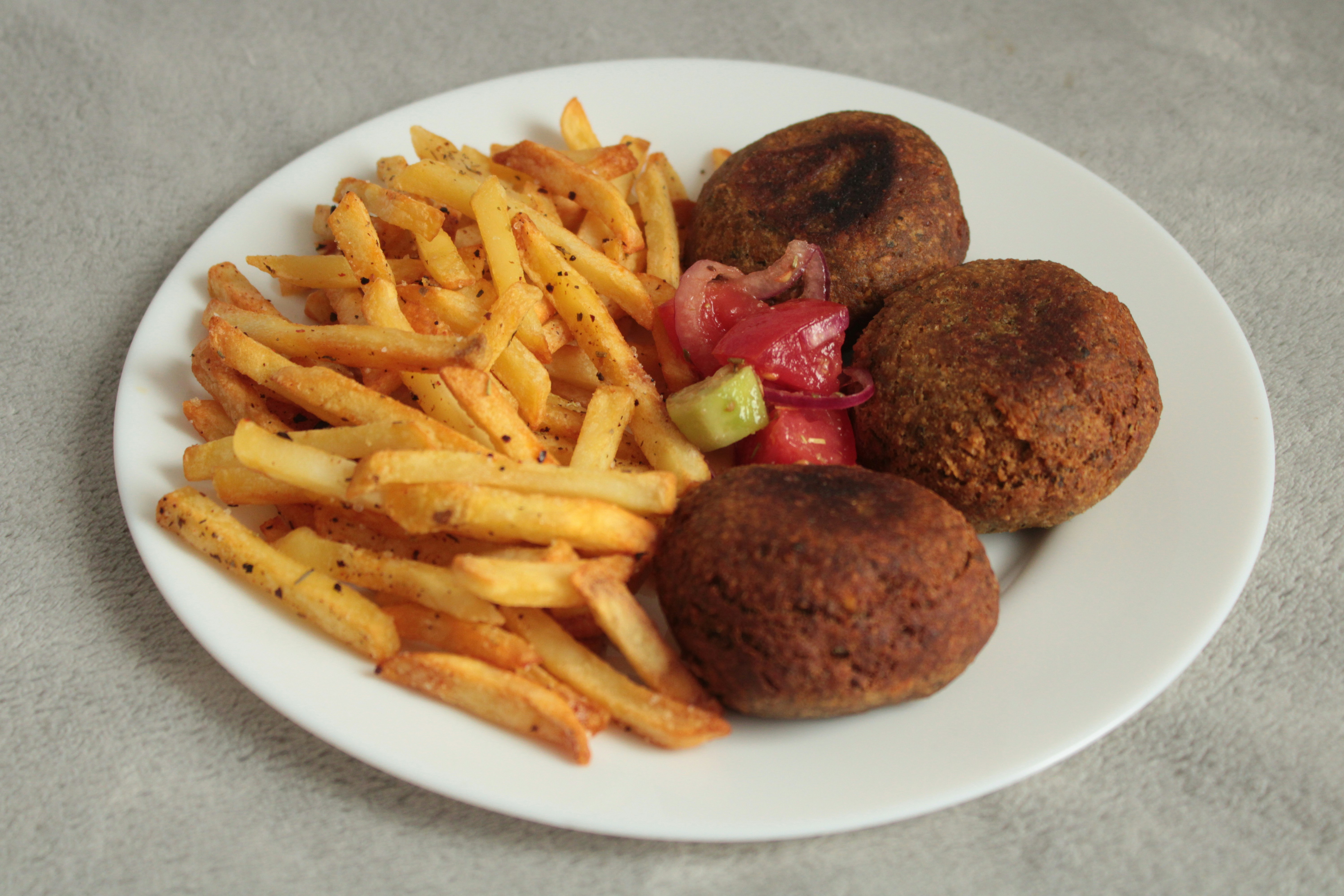 Crisped Golden Fries with Three Meatballs on a White Plate