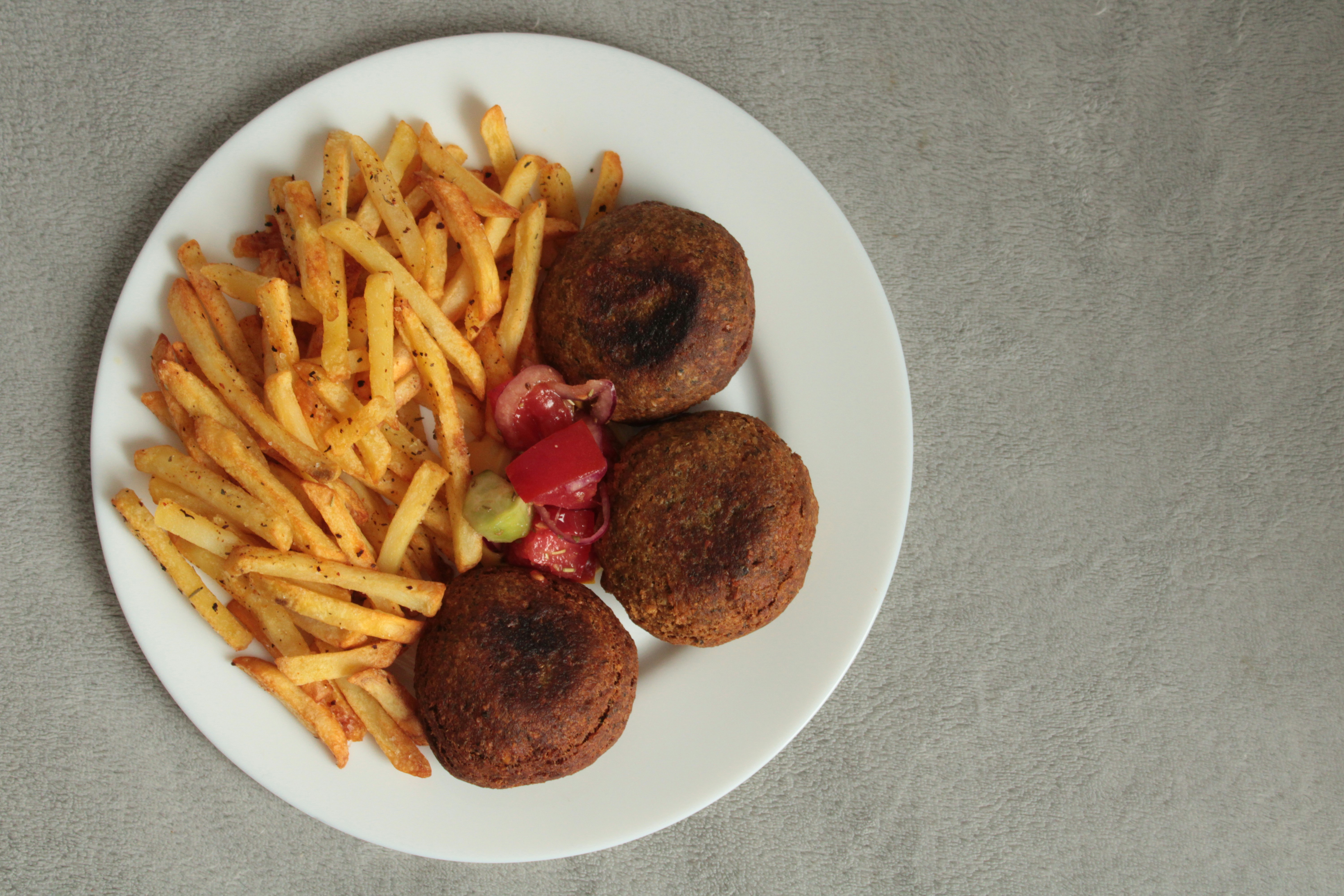 Crisped Fries and Three Croquettes on a White Plate