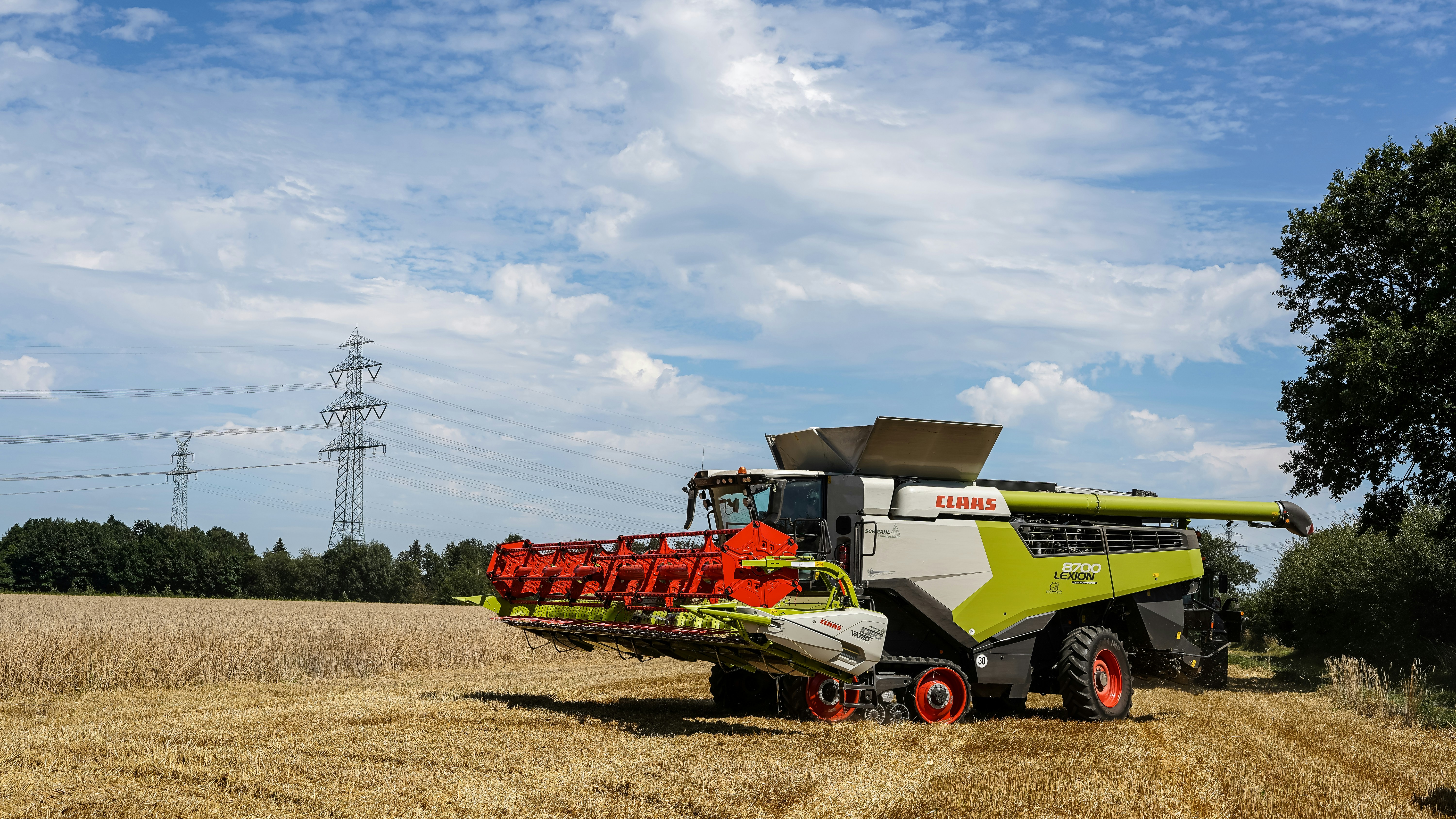 Harvesting in a Sea of Gold: A Modern Combine at Full Tilt