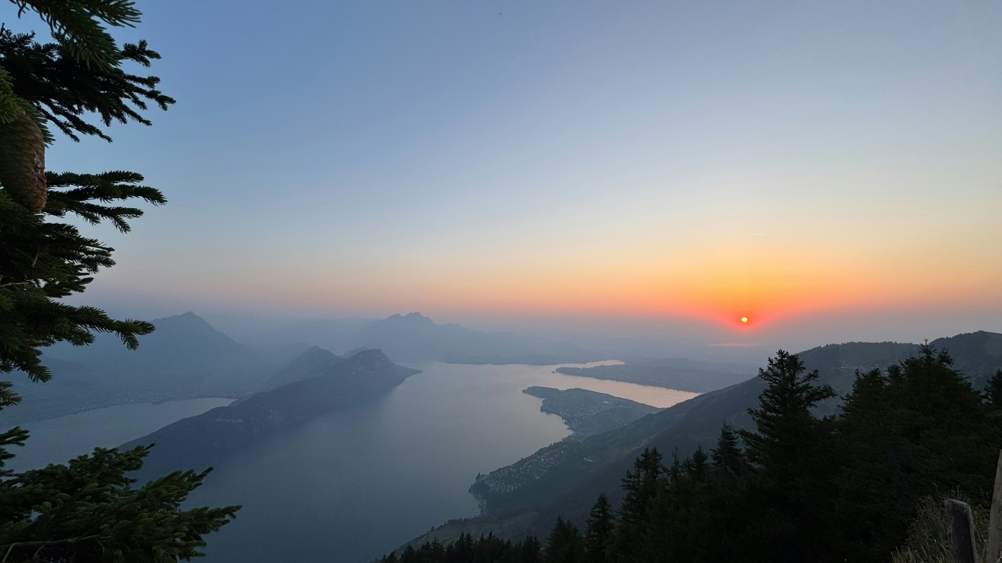 Sunset Over a Serene Fjord: Peaks, Water, and Twilight