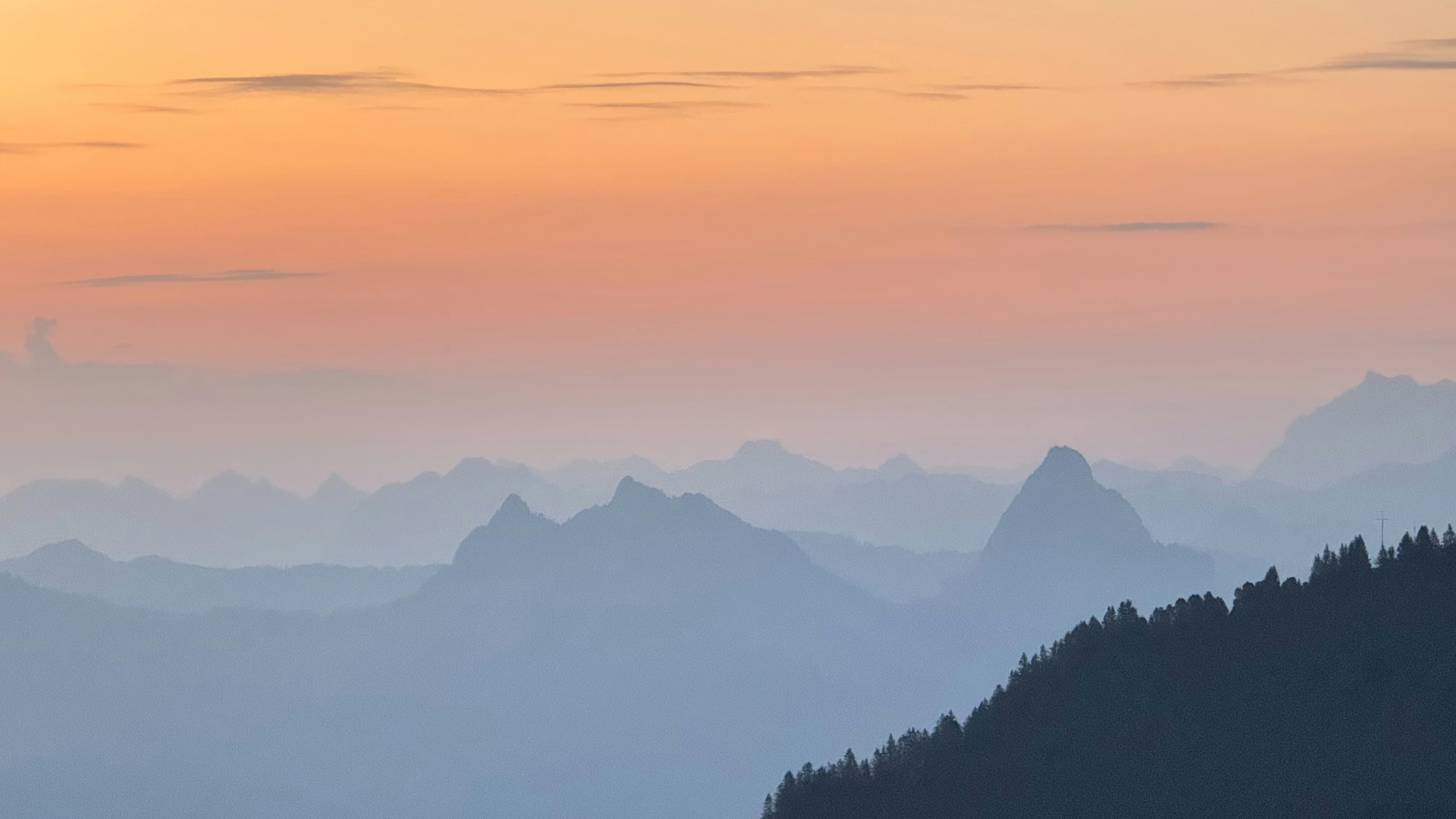 Dawn Silhouettes Over Quiet Peaks