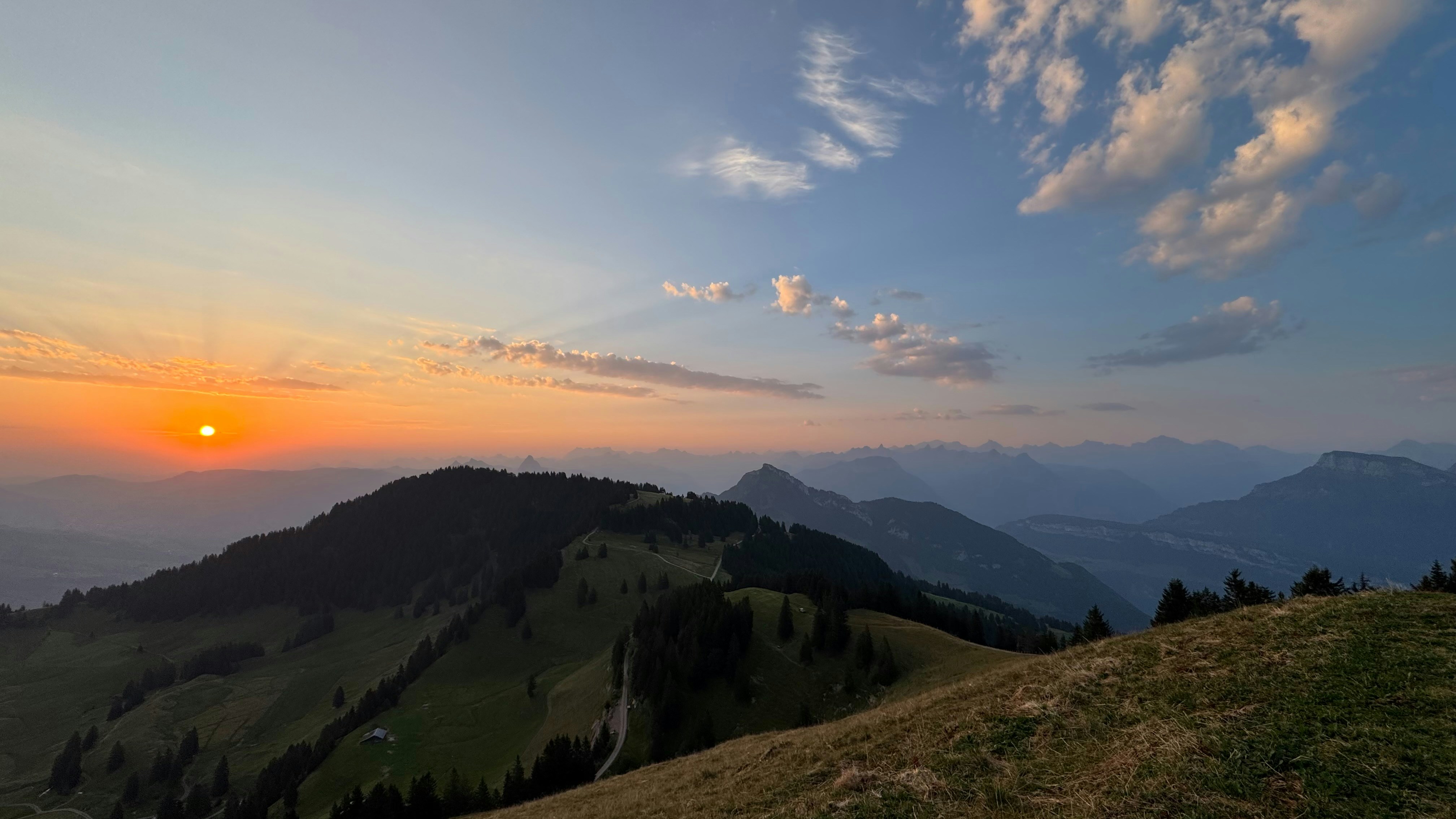 Sunset Over Rolling Alps: A Quiet Crest with Distant Vistas