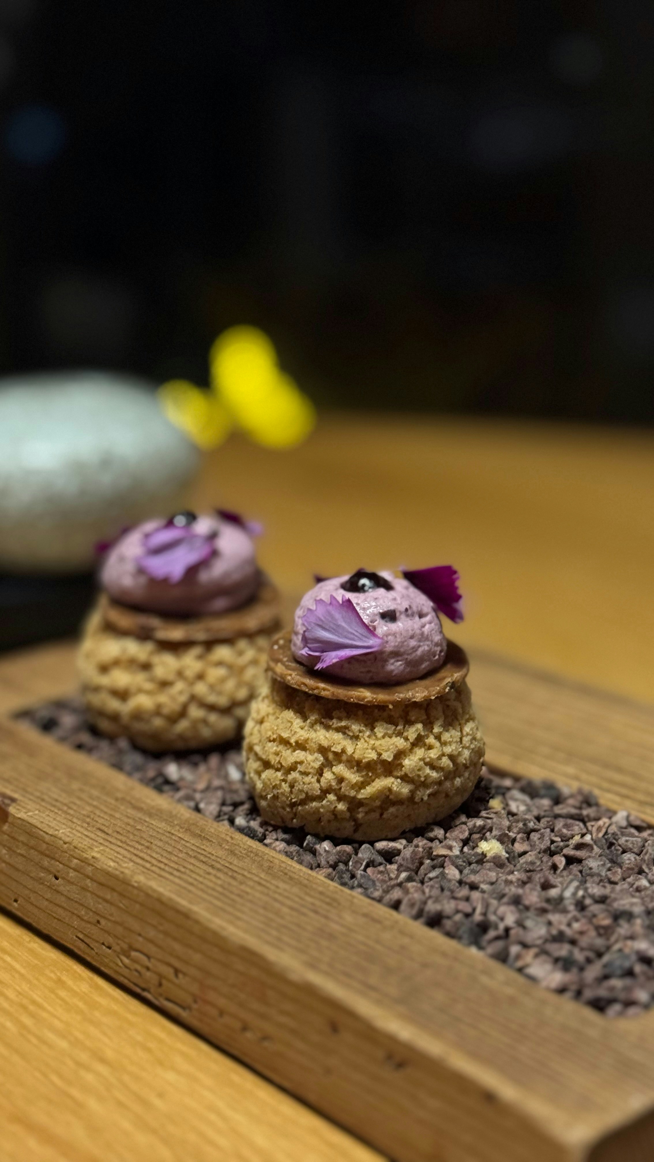 Midnight Delights: Two Petite Pastries Standing Guard on a Wooden Path