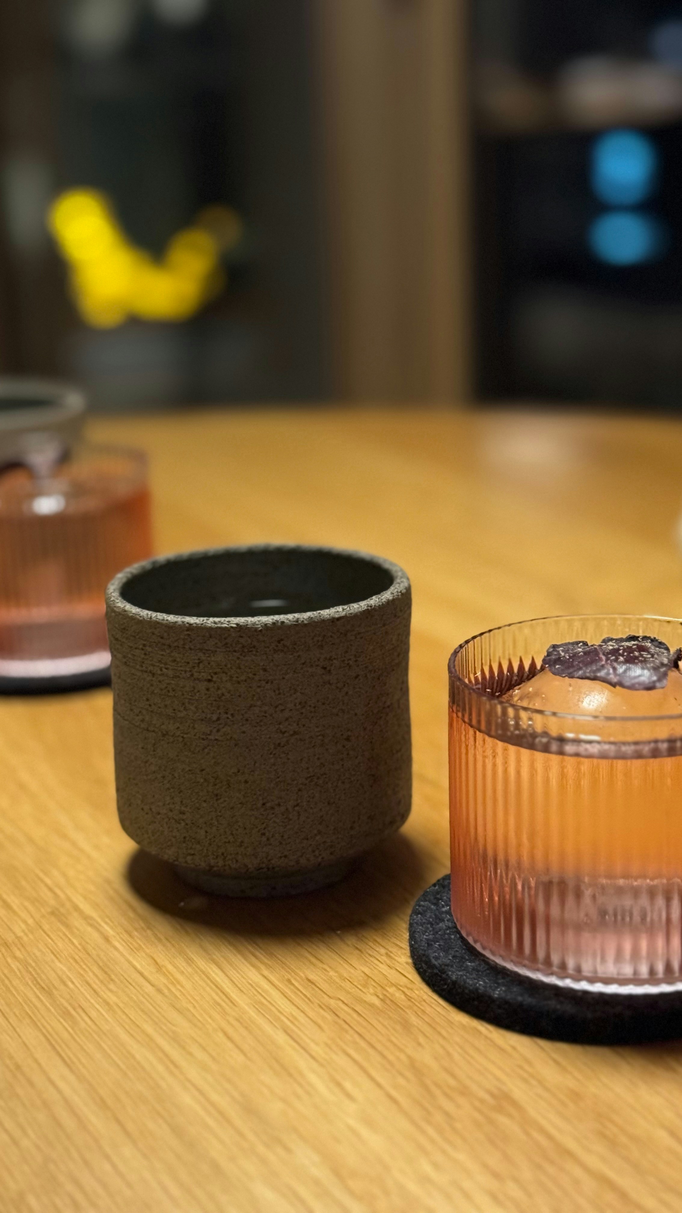 Warm Glasses and Ceramic Vessel on a Wooden Table