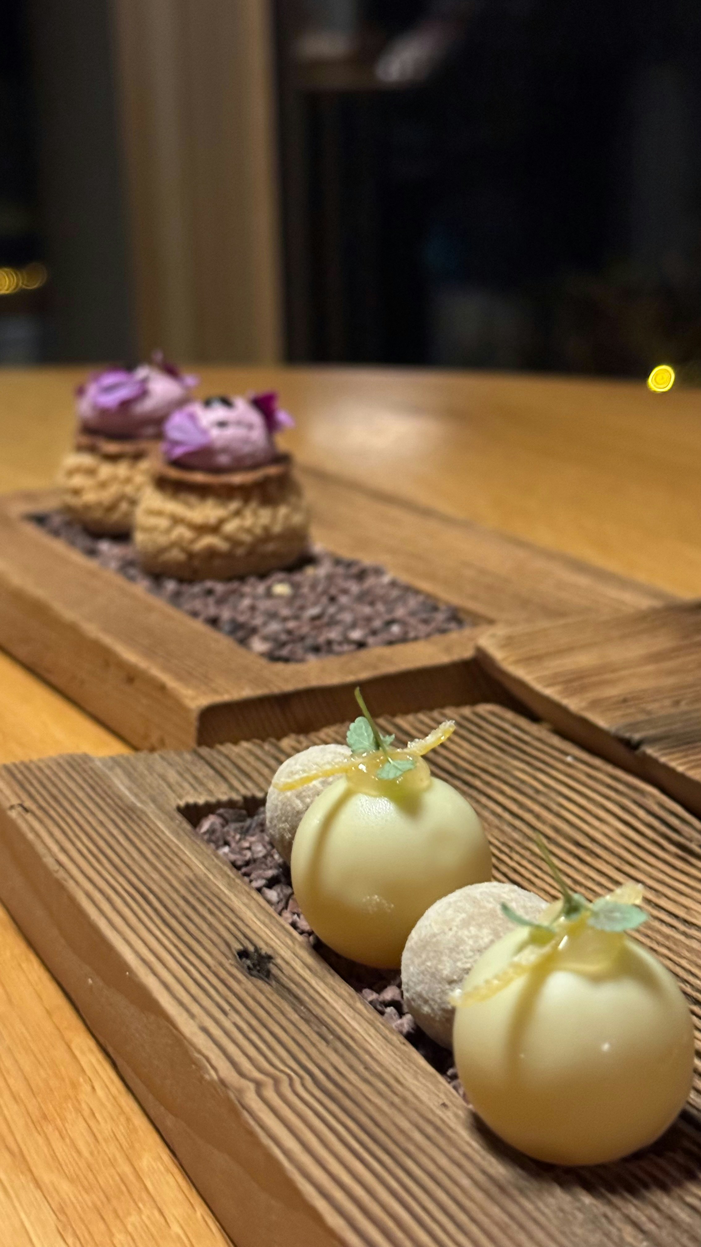 Creamy orbs on a wooden tray: a dessert vignette in warm lighting