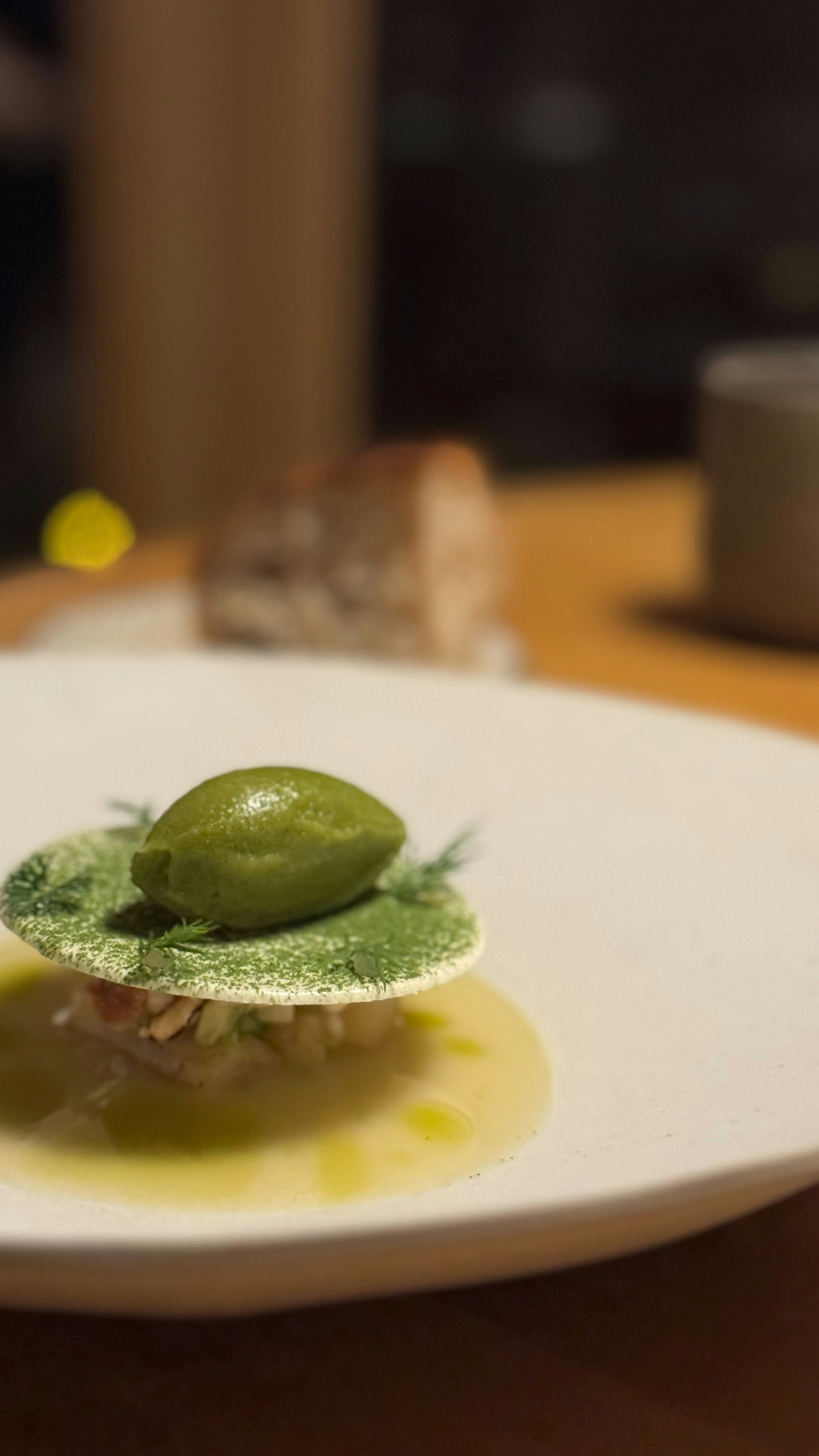 Green Sphere on a Delicate Bed: A Gourmet Bite in Soft Focus
