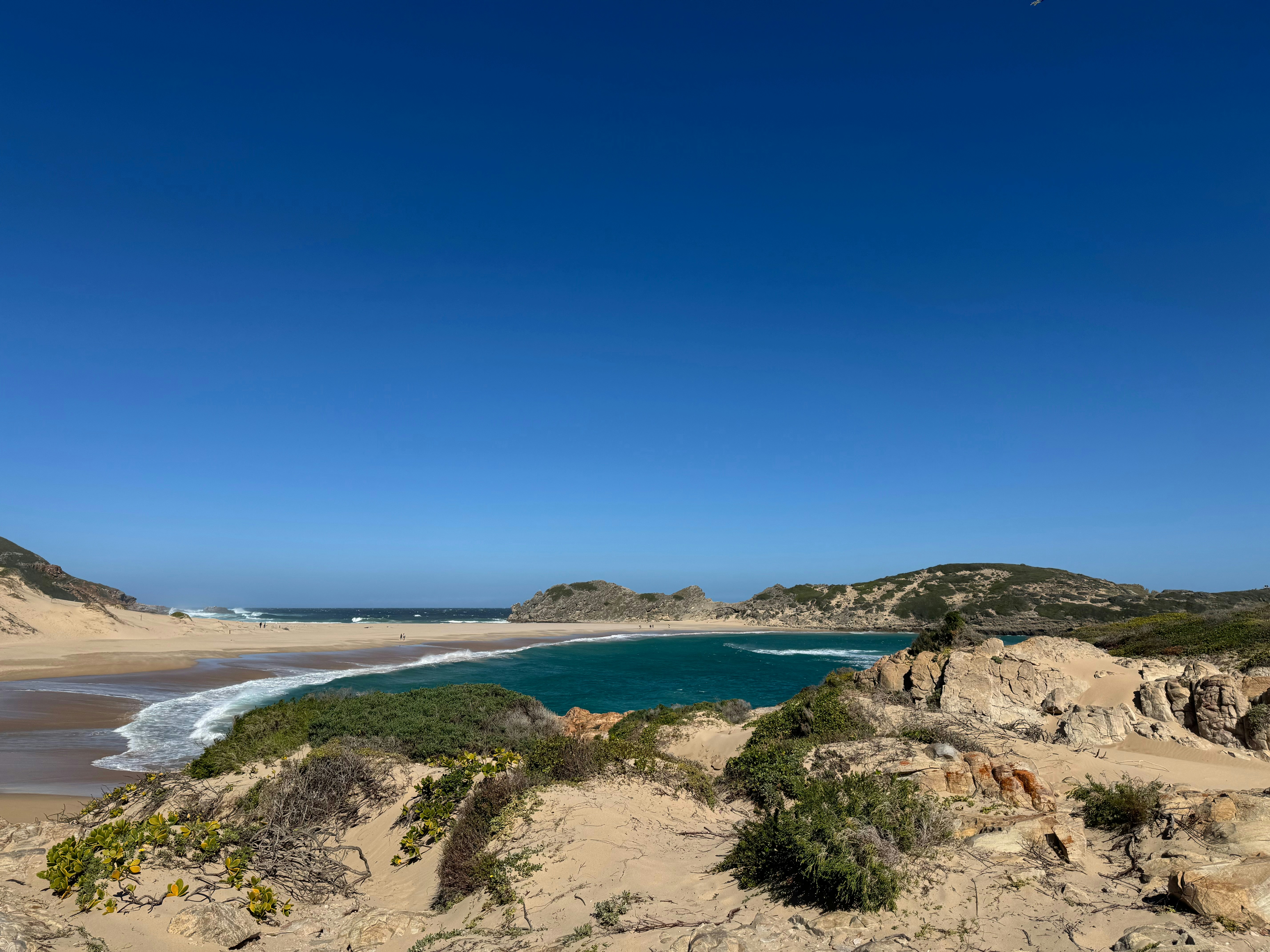 Sunlit Cove: A Quiet Canvas of Sand, Sea, and Stone
