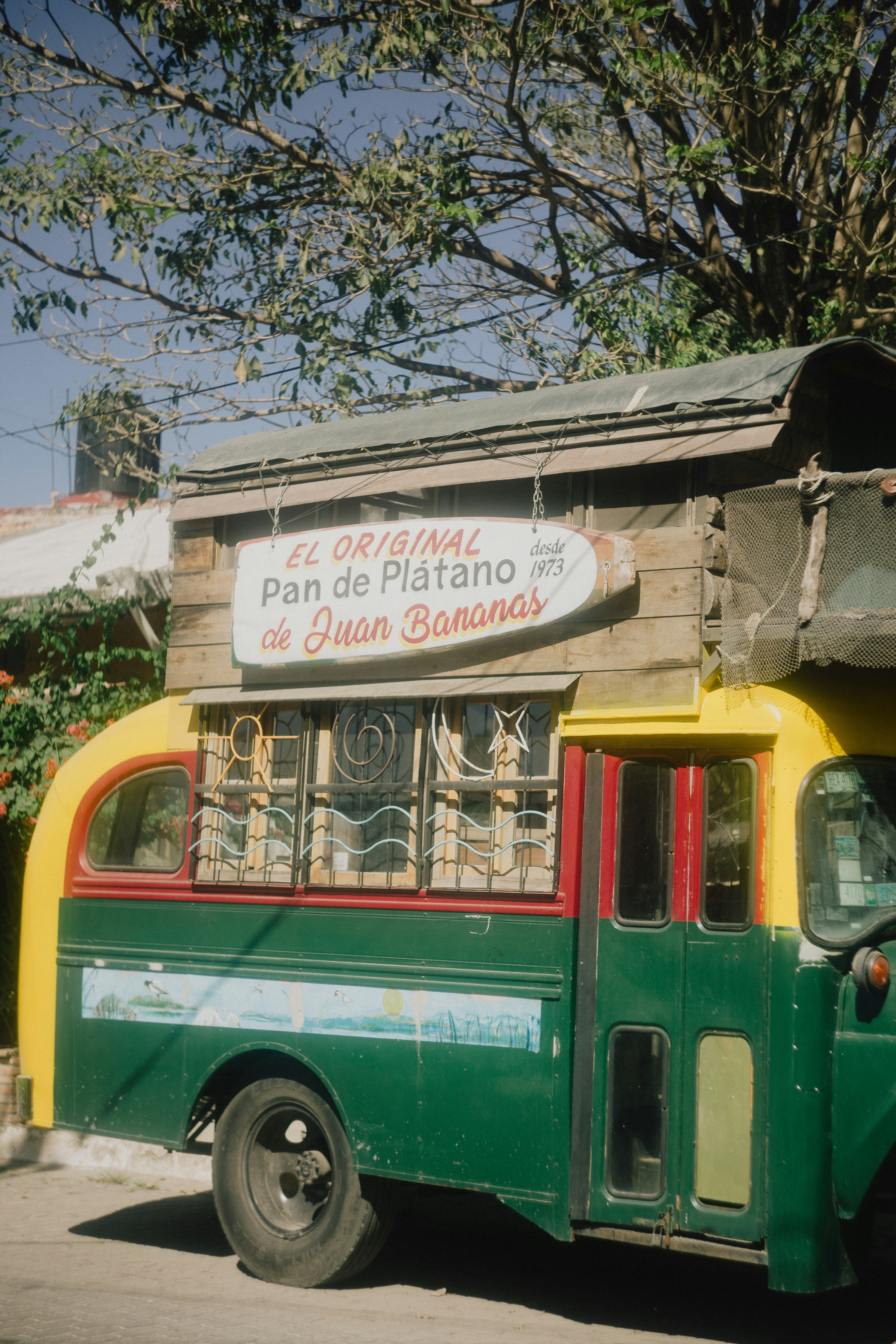Pan of Banana Bus Stop: a colorful street side with a vintage sign