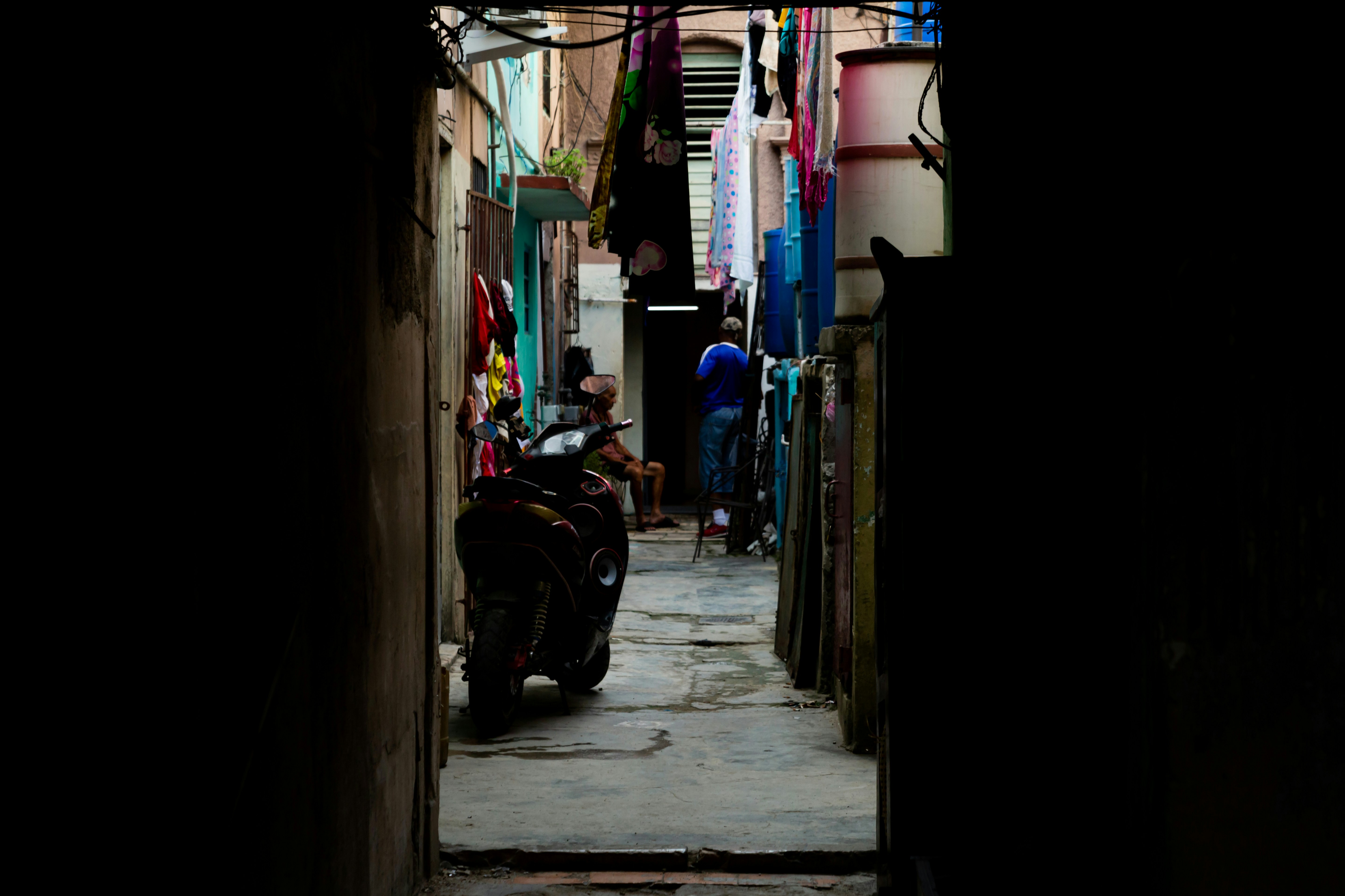 Alleyway Portrait: Quiet Moment Beneath Laundry Hangs