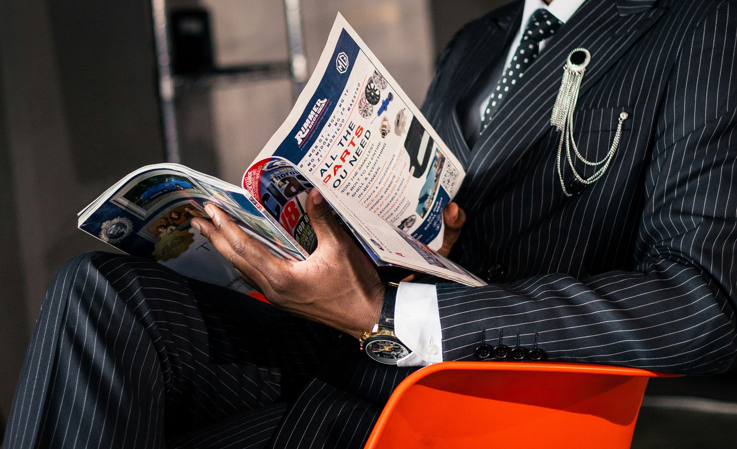 Pinstripe Reading: A Power Suit Delving into a Magazine