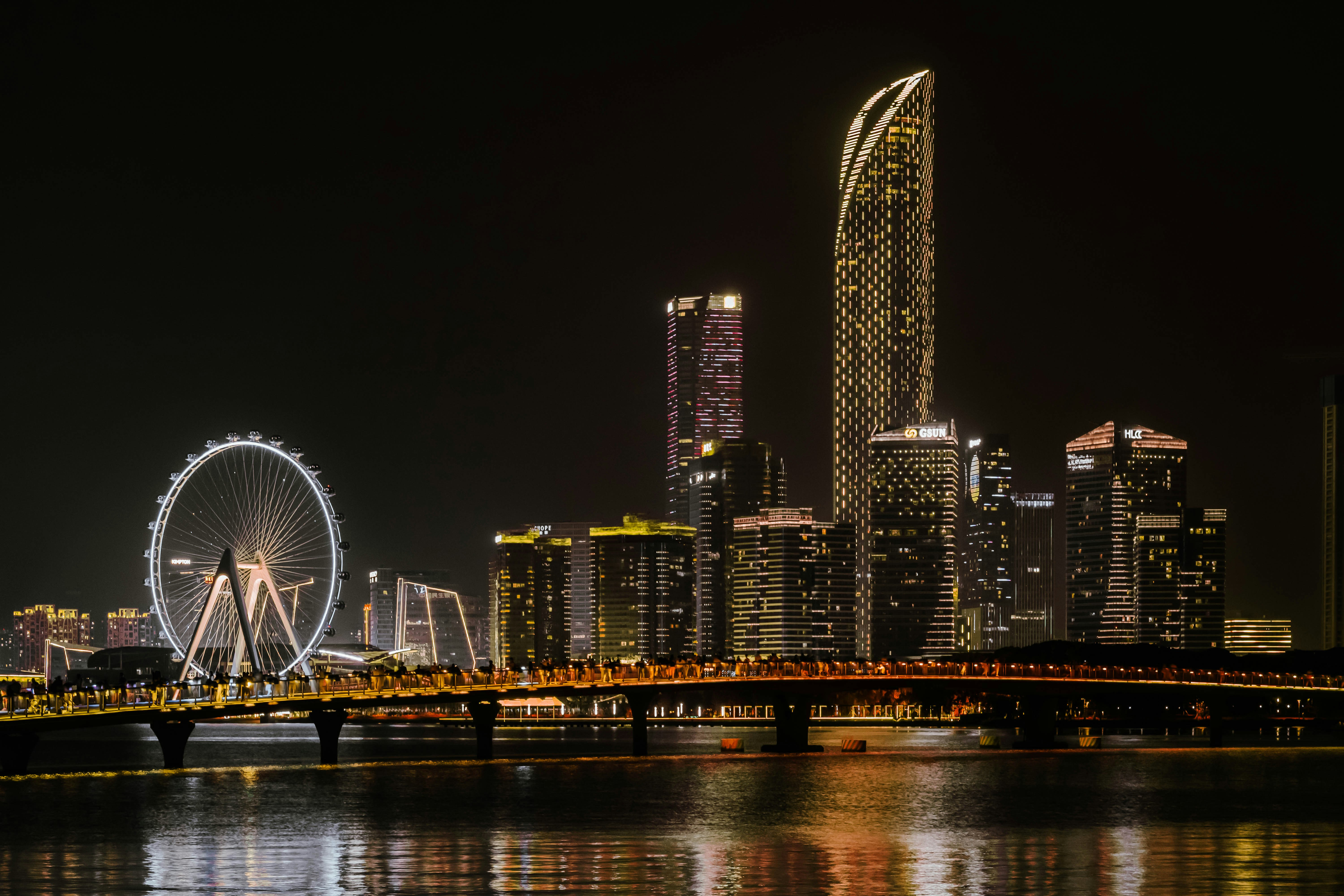 Nightfall Over a Glowing Skyline with the Ferris Wheel