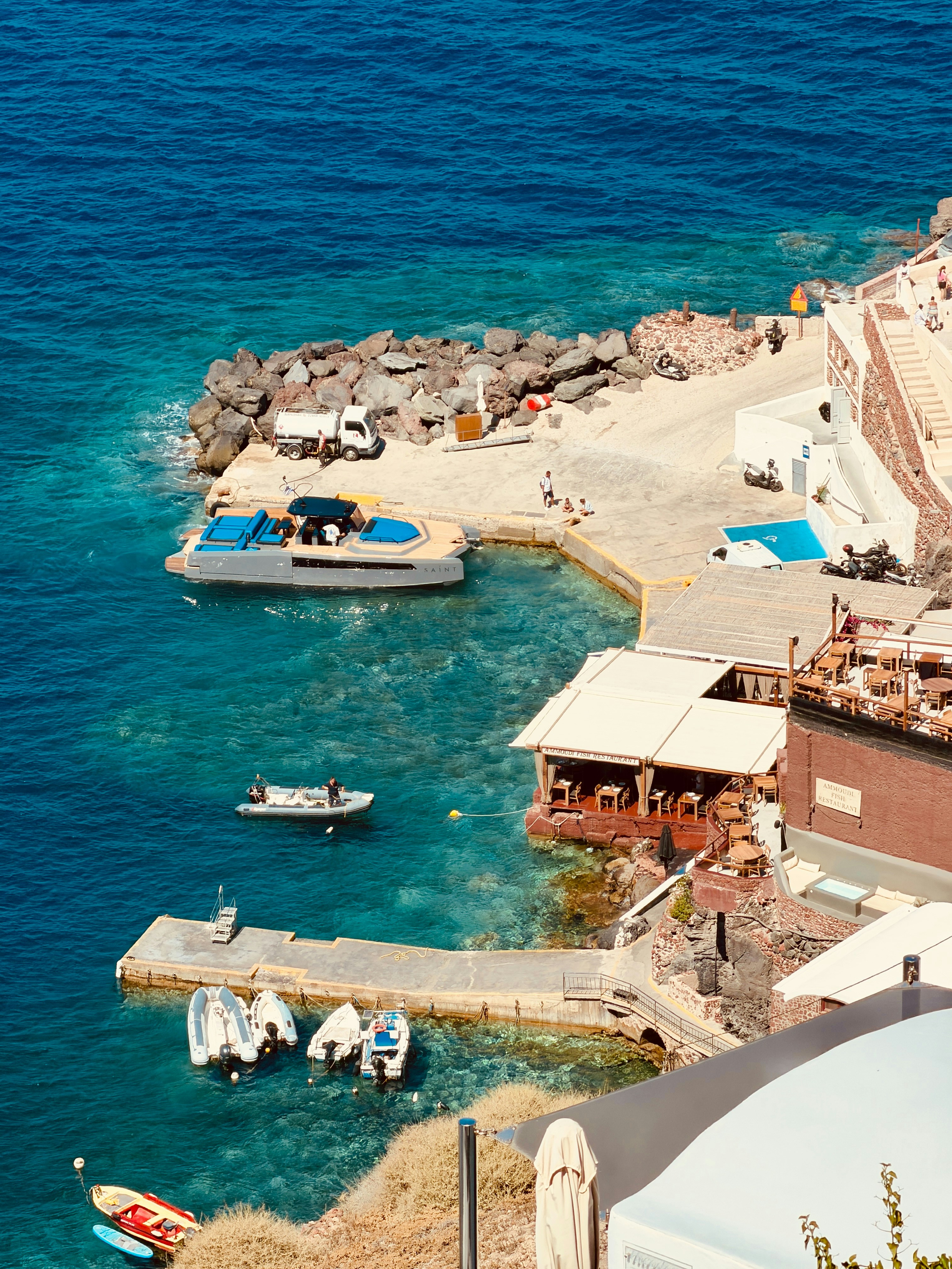 Harbor Terrace: Boats, Rocks, and Sunlit Whites