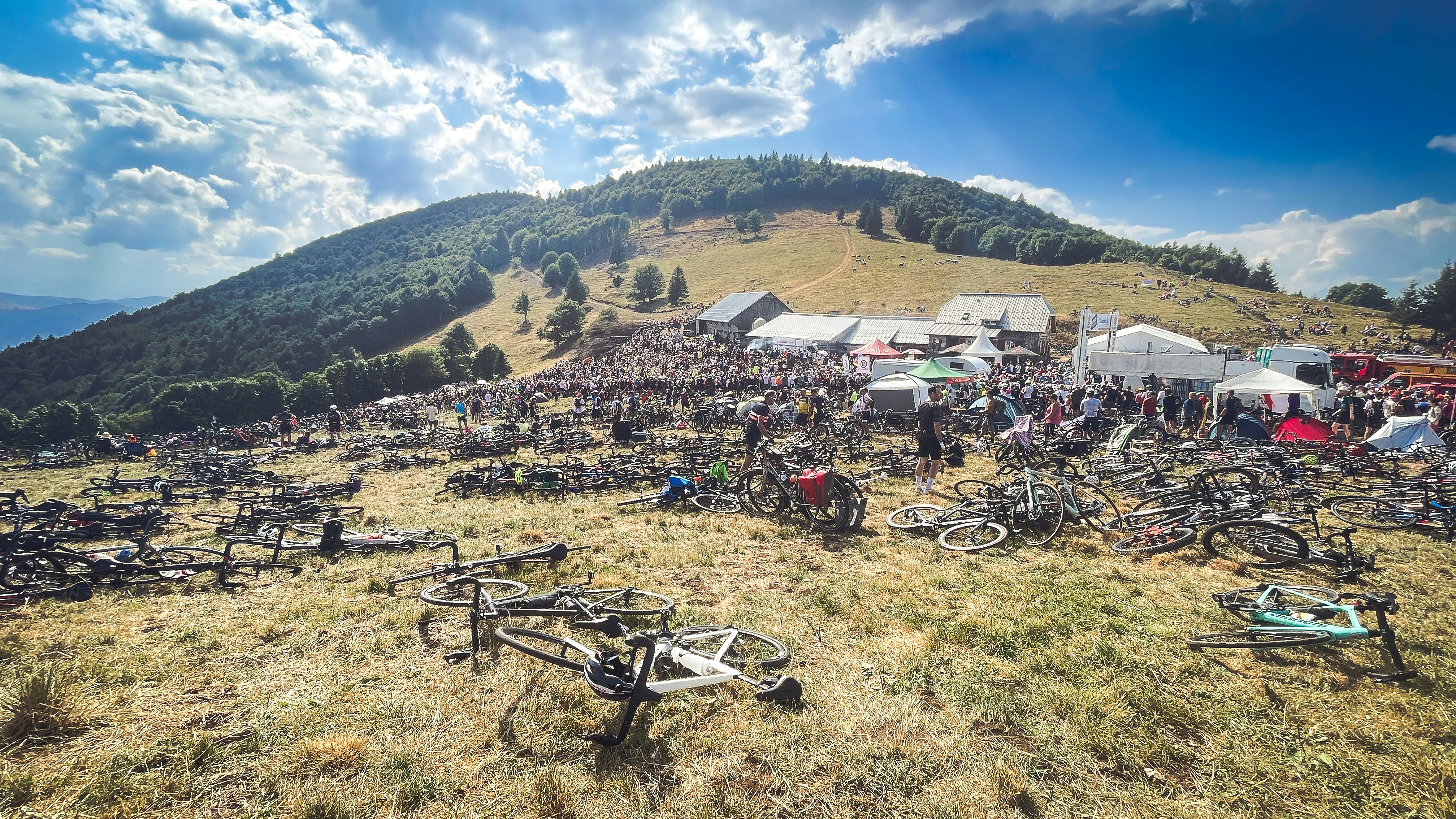Sunlit Summit Bike Rally Beneath a Bustling Crowd