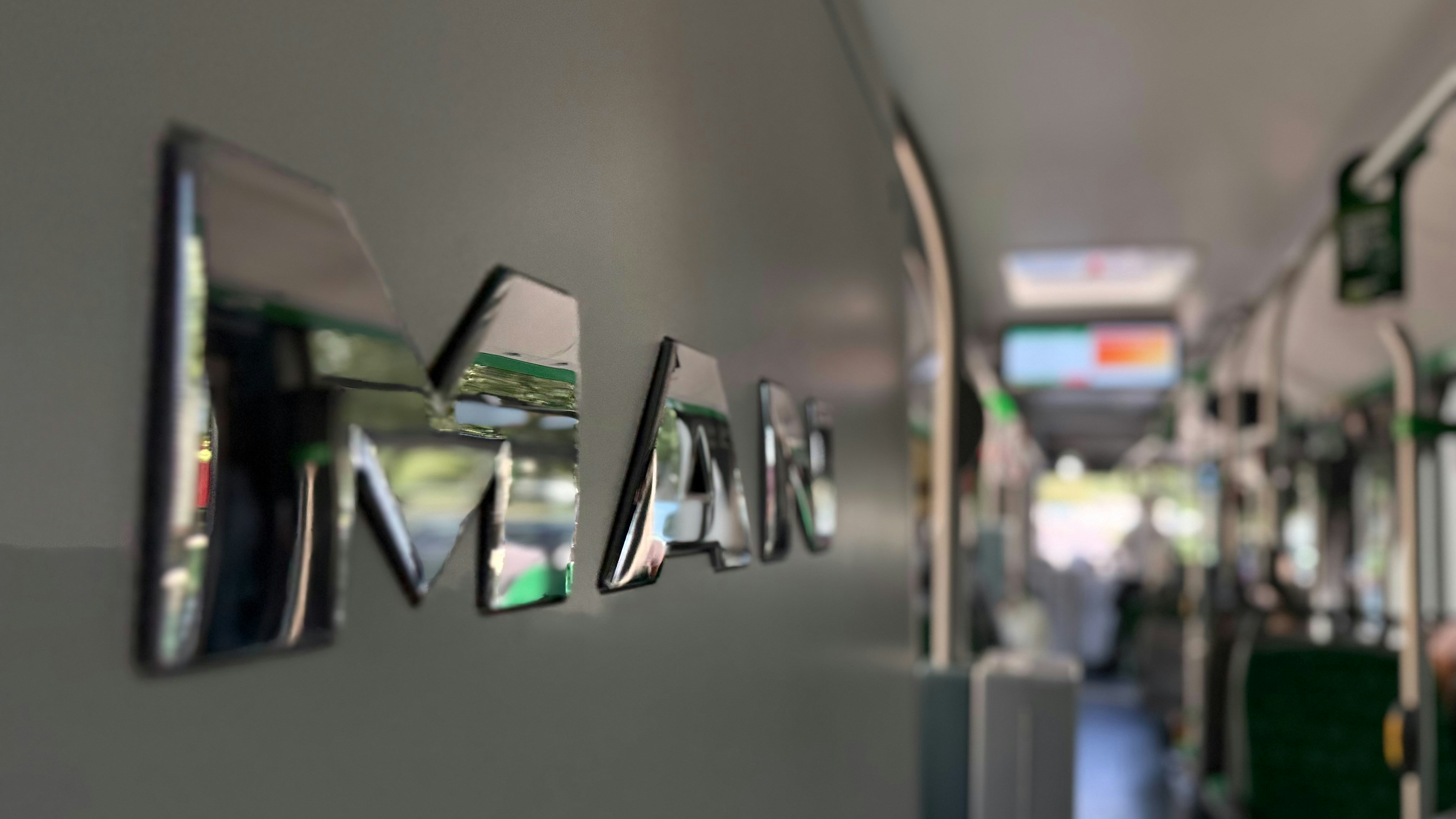 Chrome Emblems in a Quiet Bus Corridor