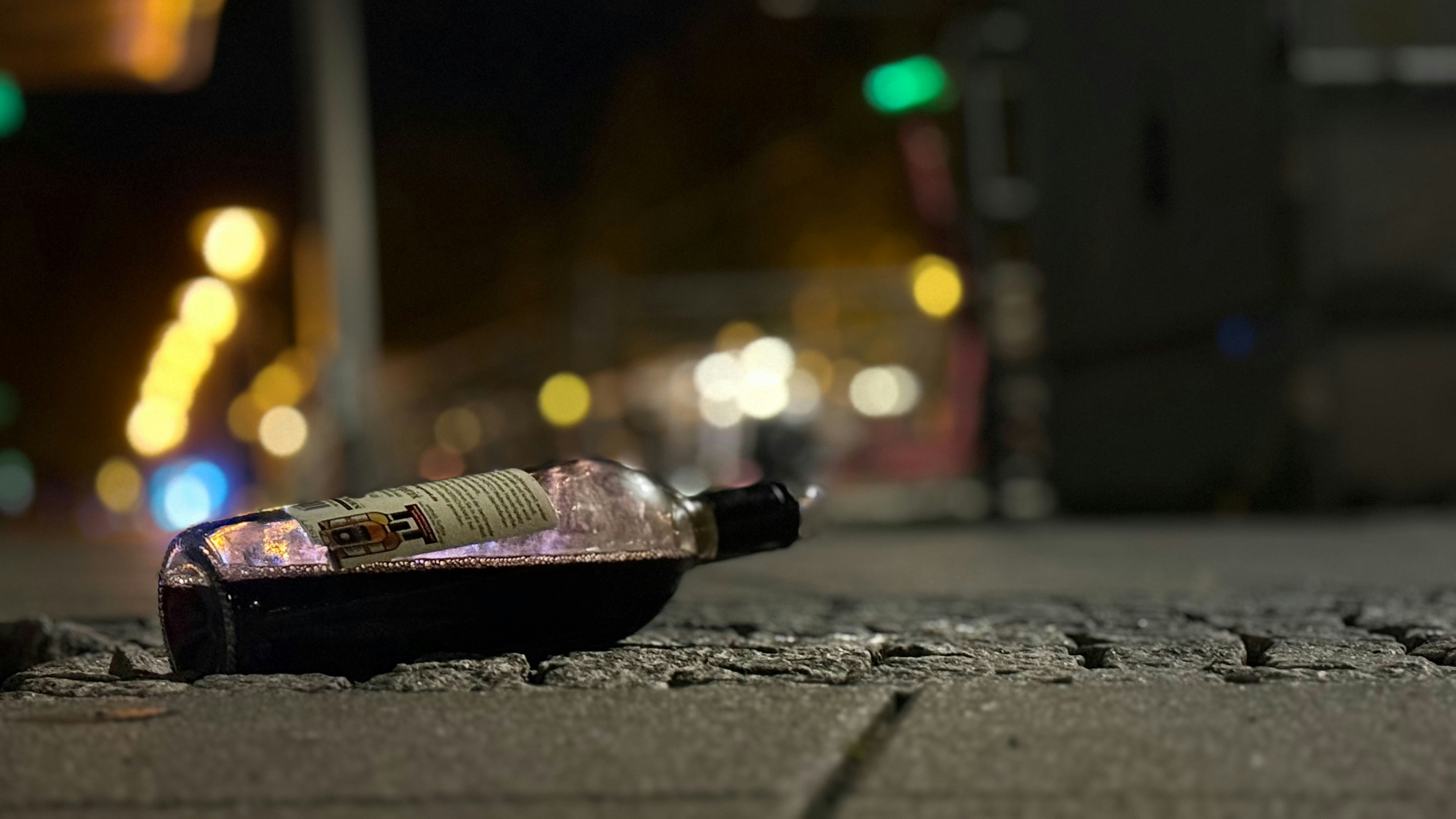 Forgotten Bottle on a City Street