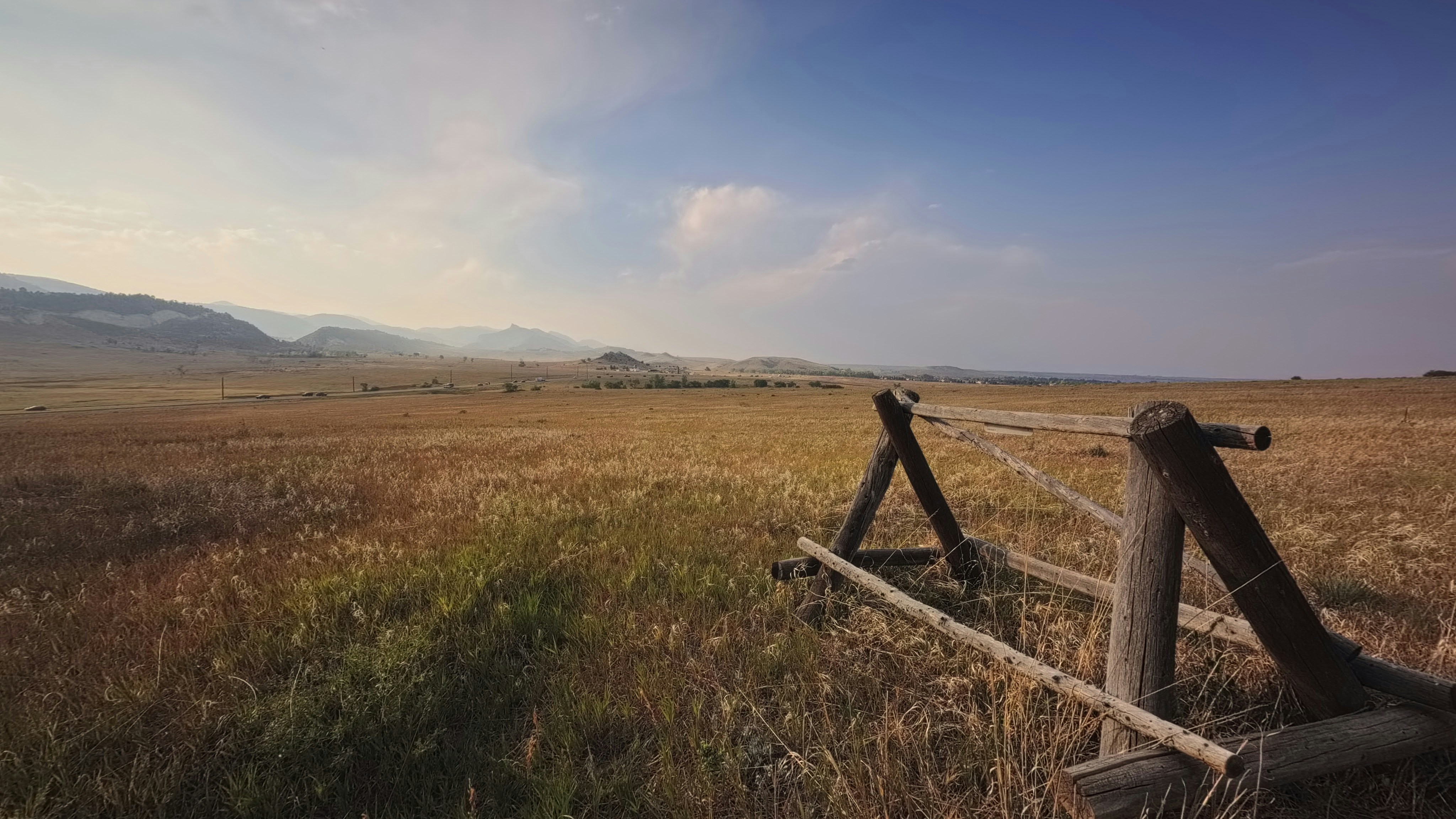 Open Range and Weathered Fence: A Quiet Prairie at Dusk