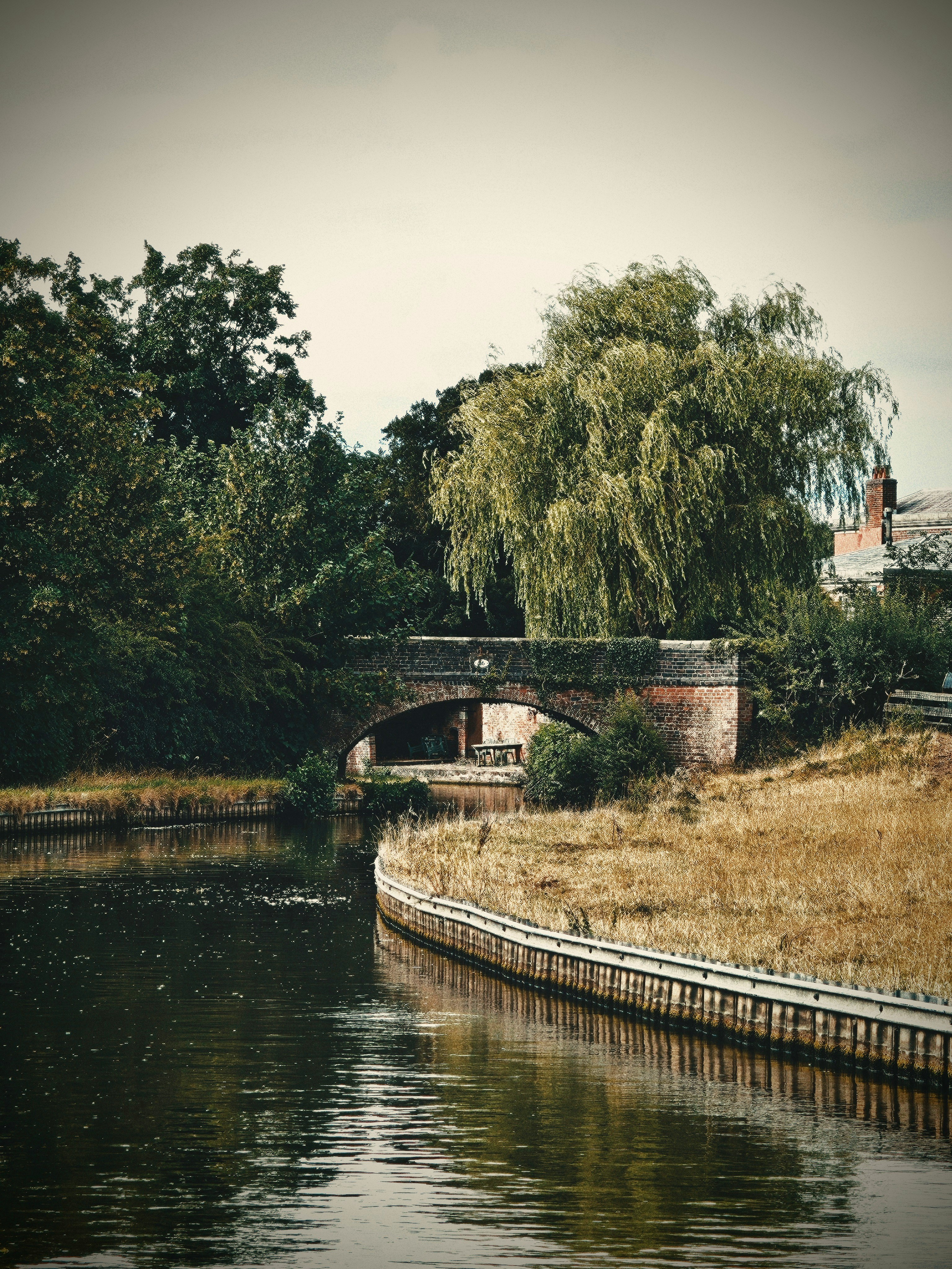 Bridged Quiet: A Brick Arch Over Calm River