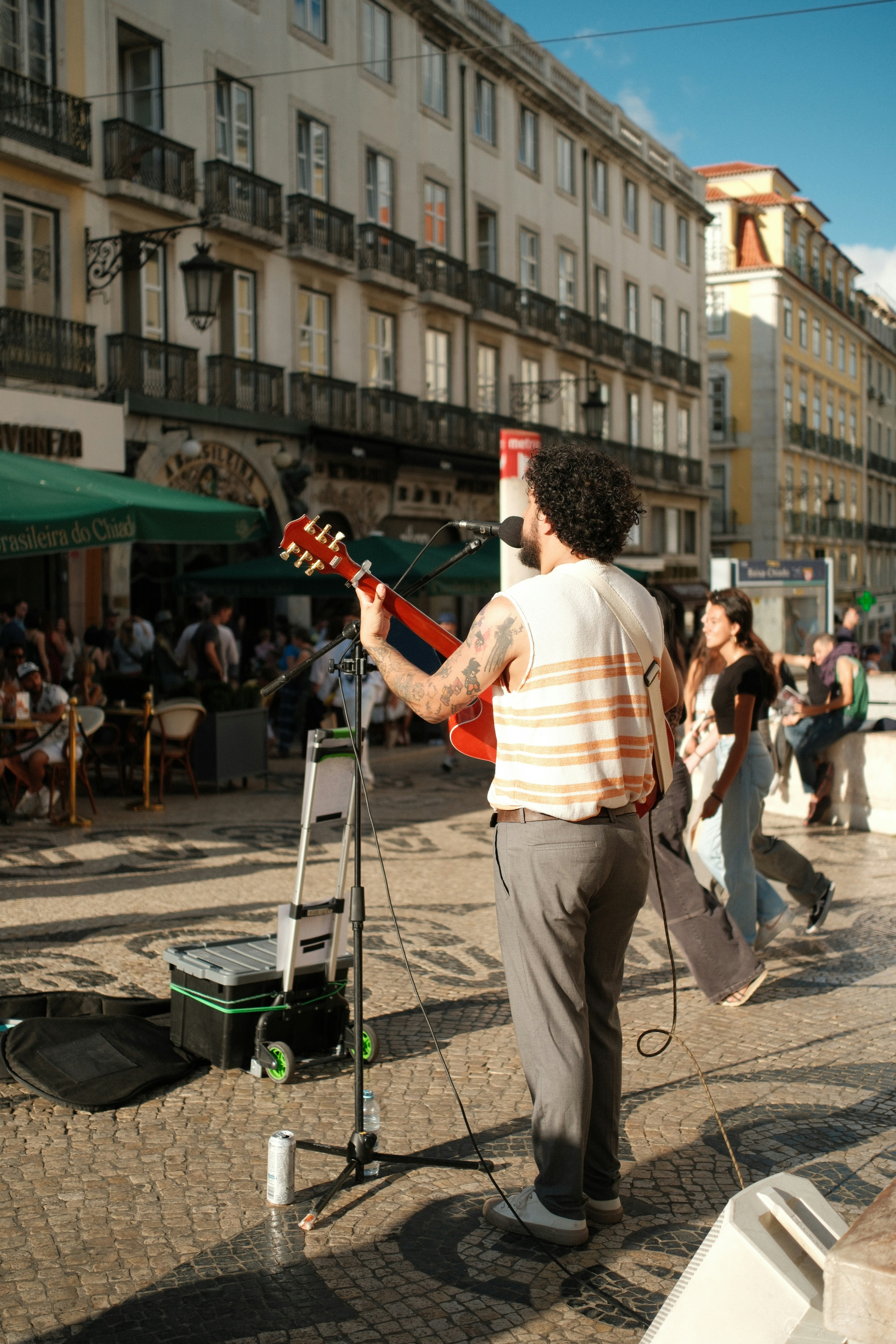 Guitarist in City Square: Sunlit Spotlight on Street Performance