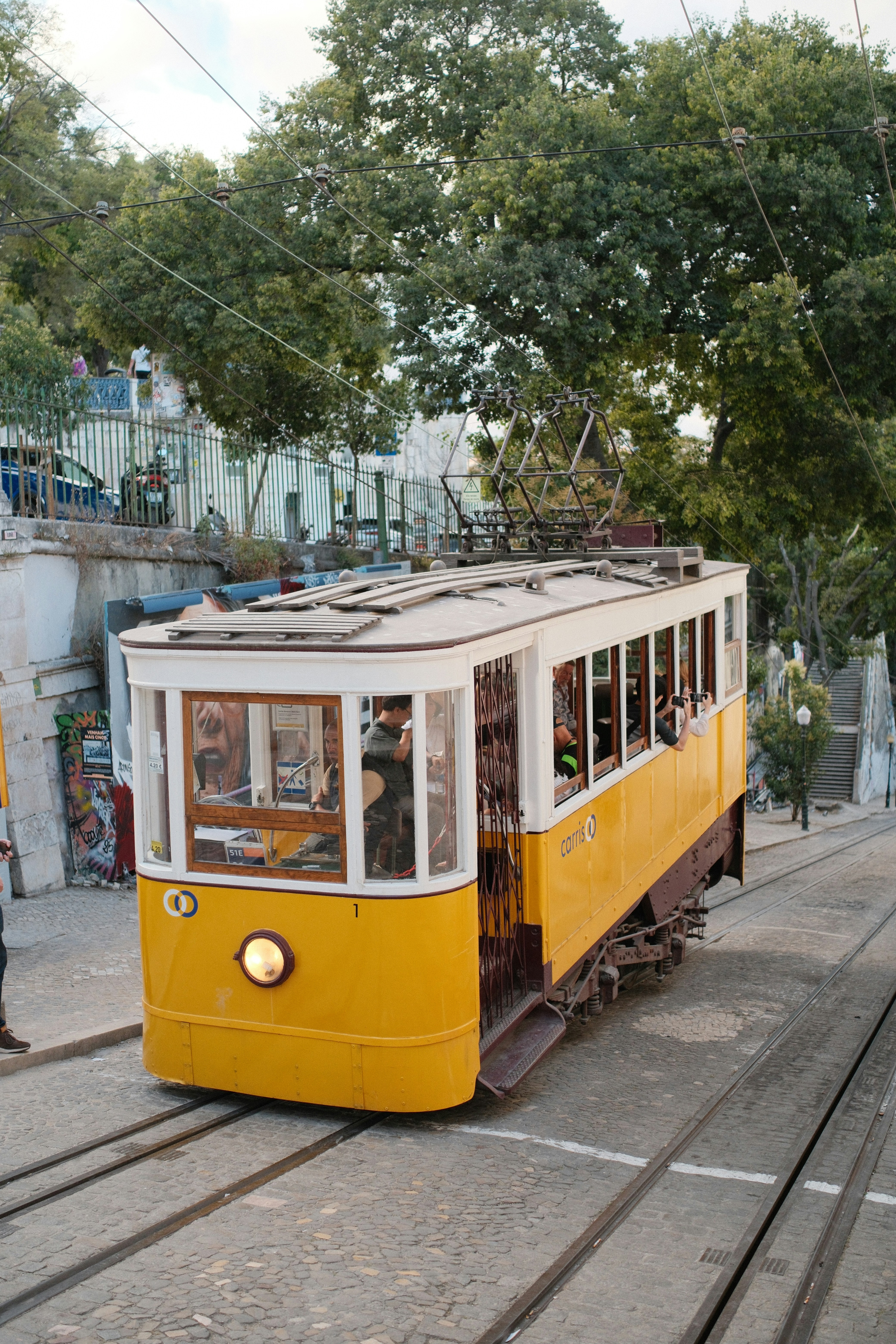Golden Streetcar on Sloped Tracks in a European Quarter