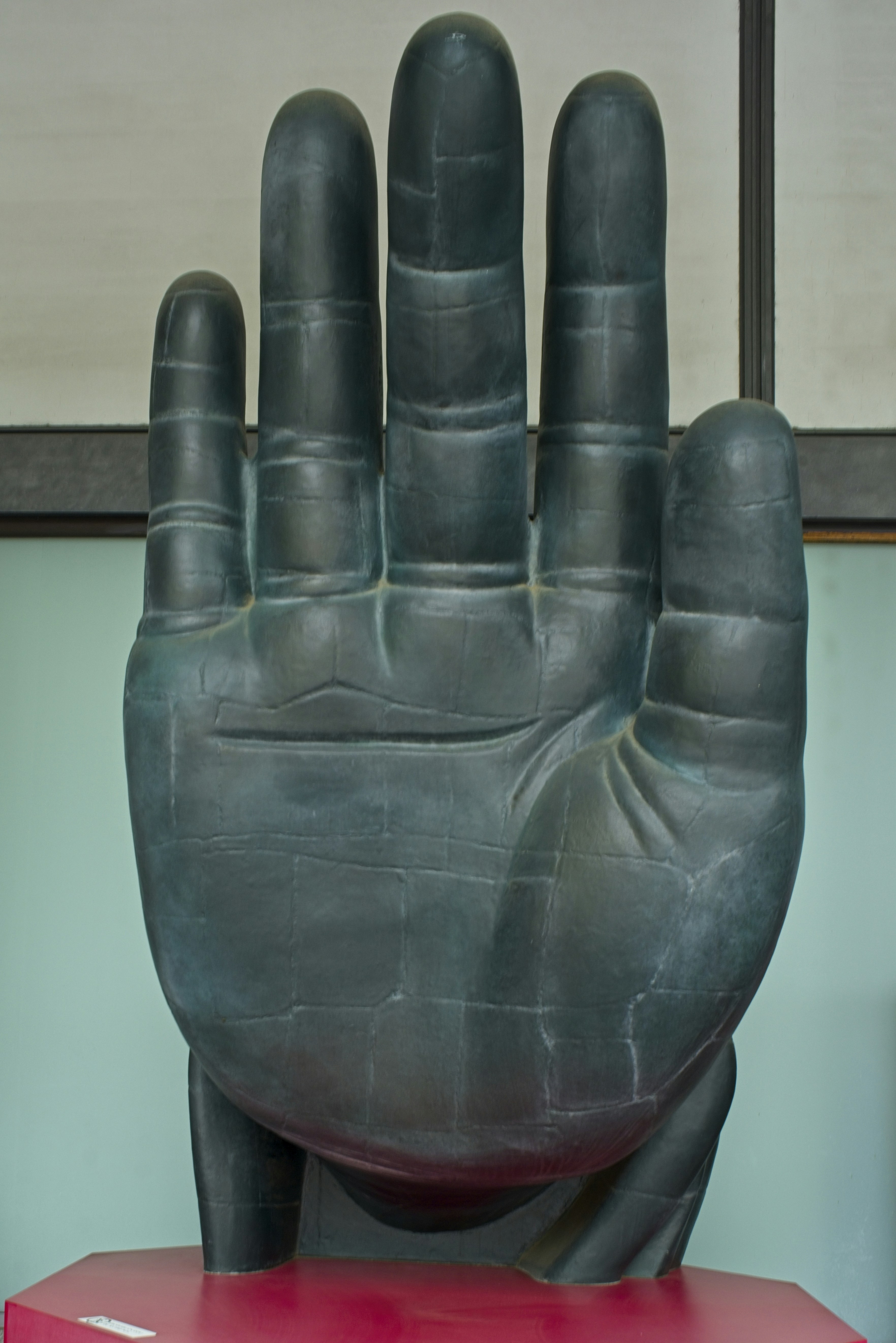 Giant teal hand on display: a sculptural centerpiece
