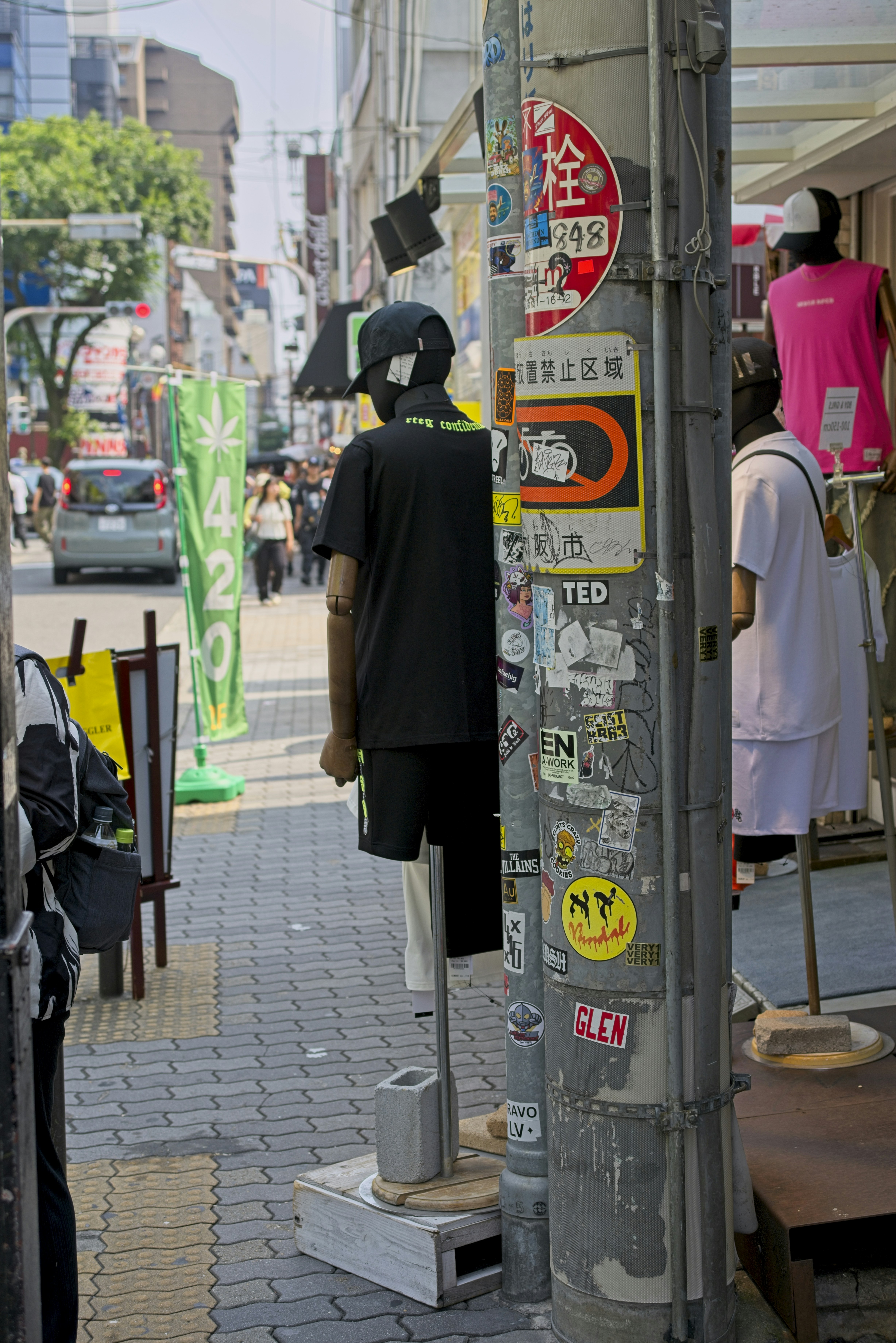 Street Portrait Beneath a Wall of Stickers