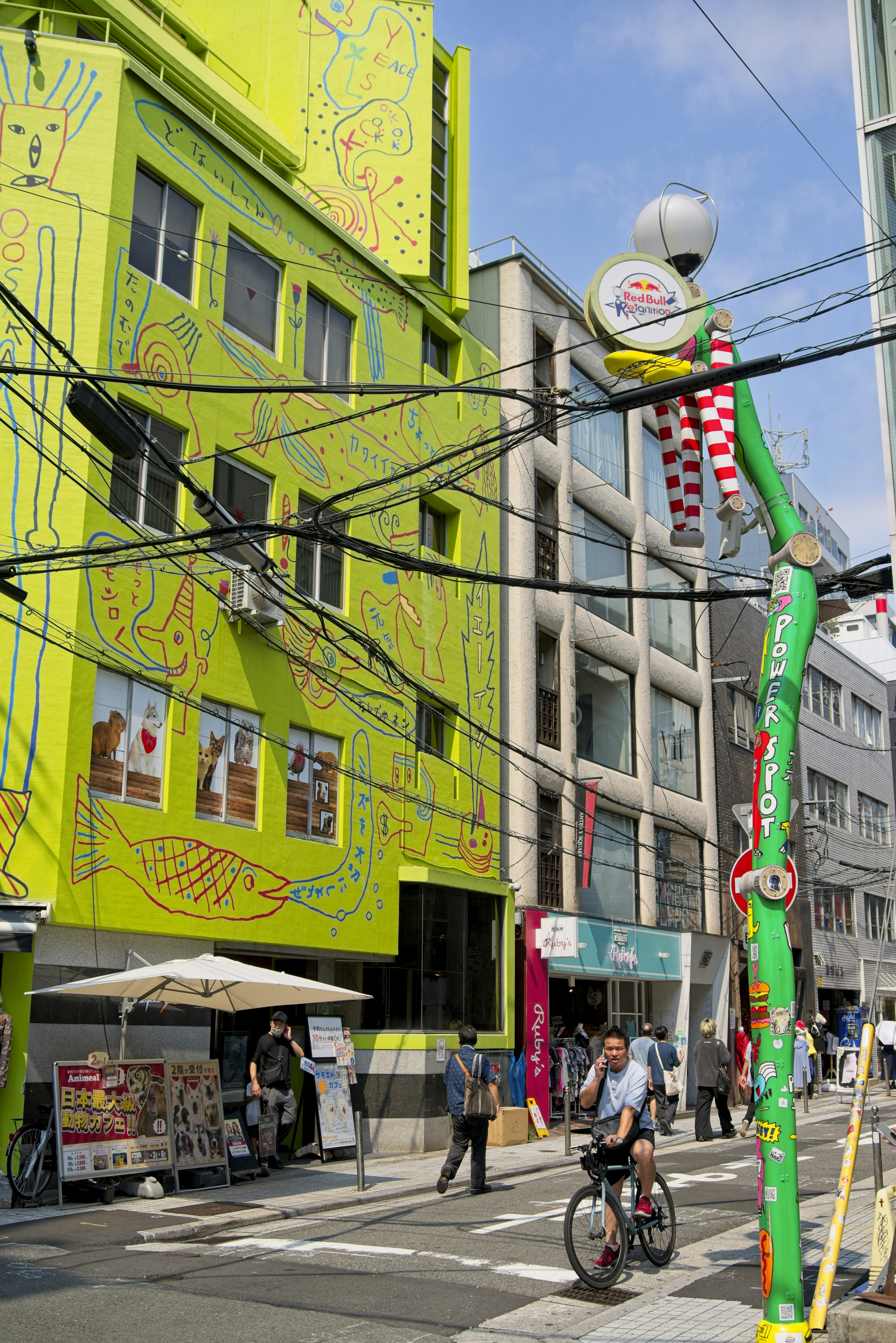 Neon-green mural cityscape haloed by tangled power lines