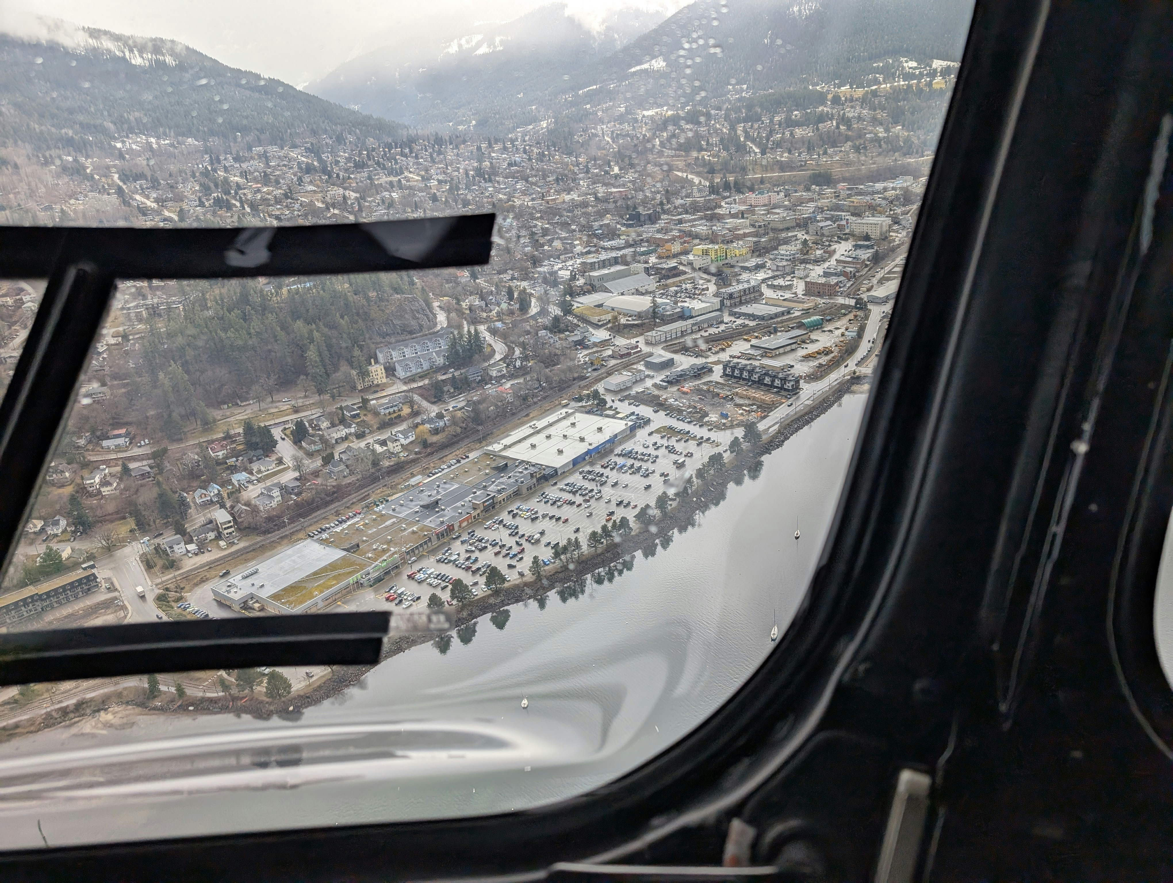 Aerial Glide Over Town and River from Cockpit Window