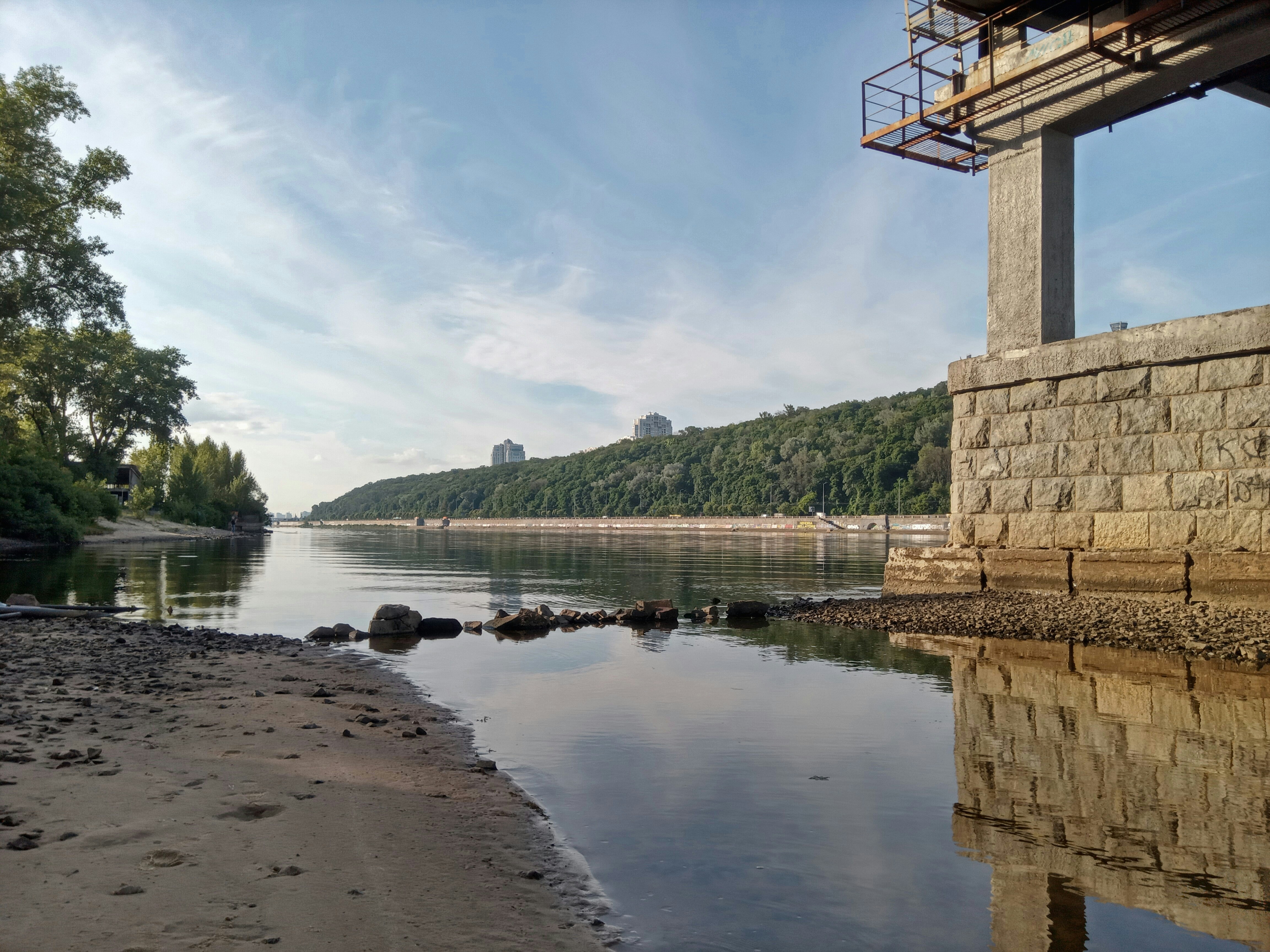 Bridge Shadow over the Quiet Riverbank