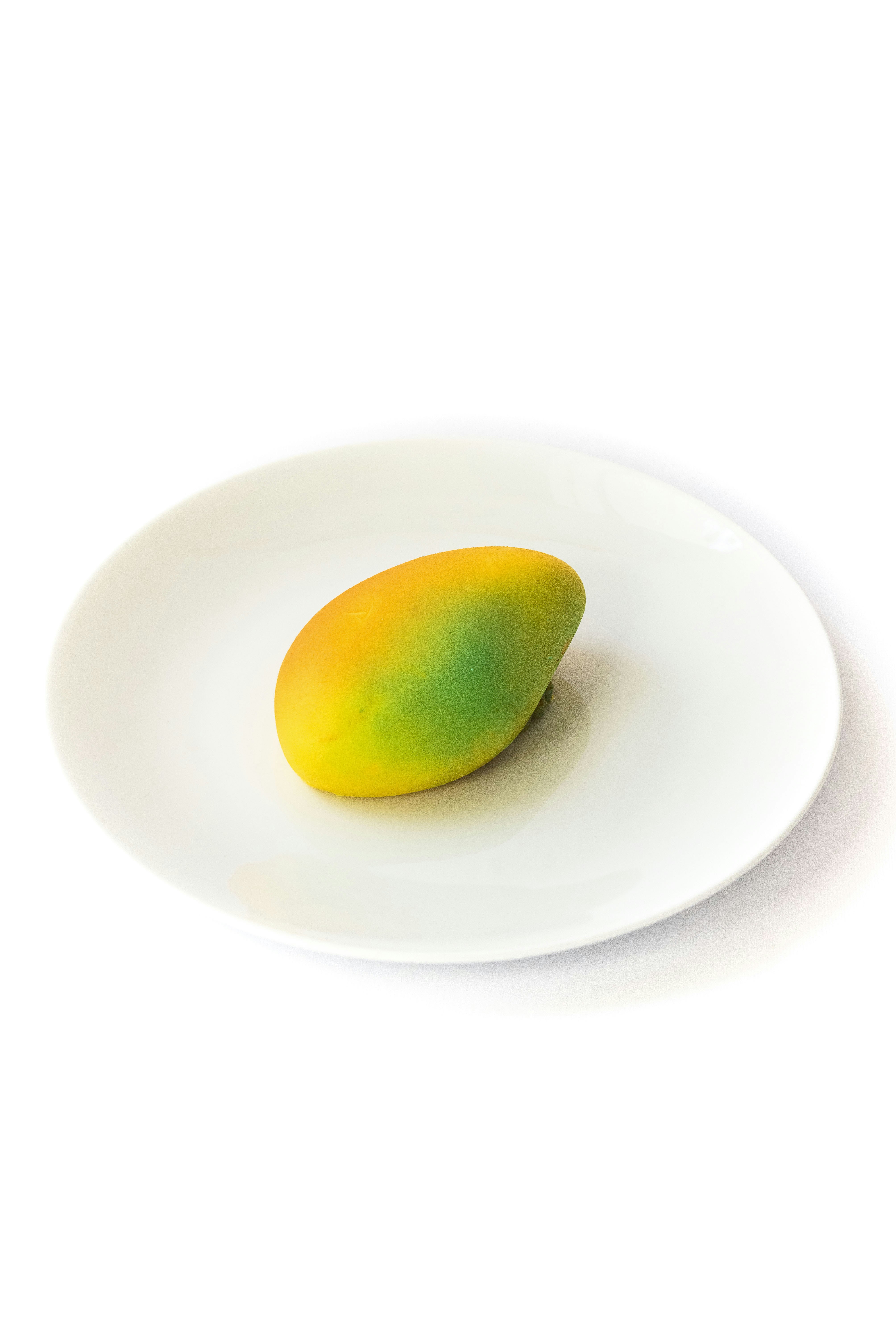 Lemon Mango Mosaic: A Single Mango on White Silence