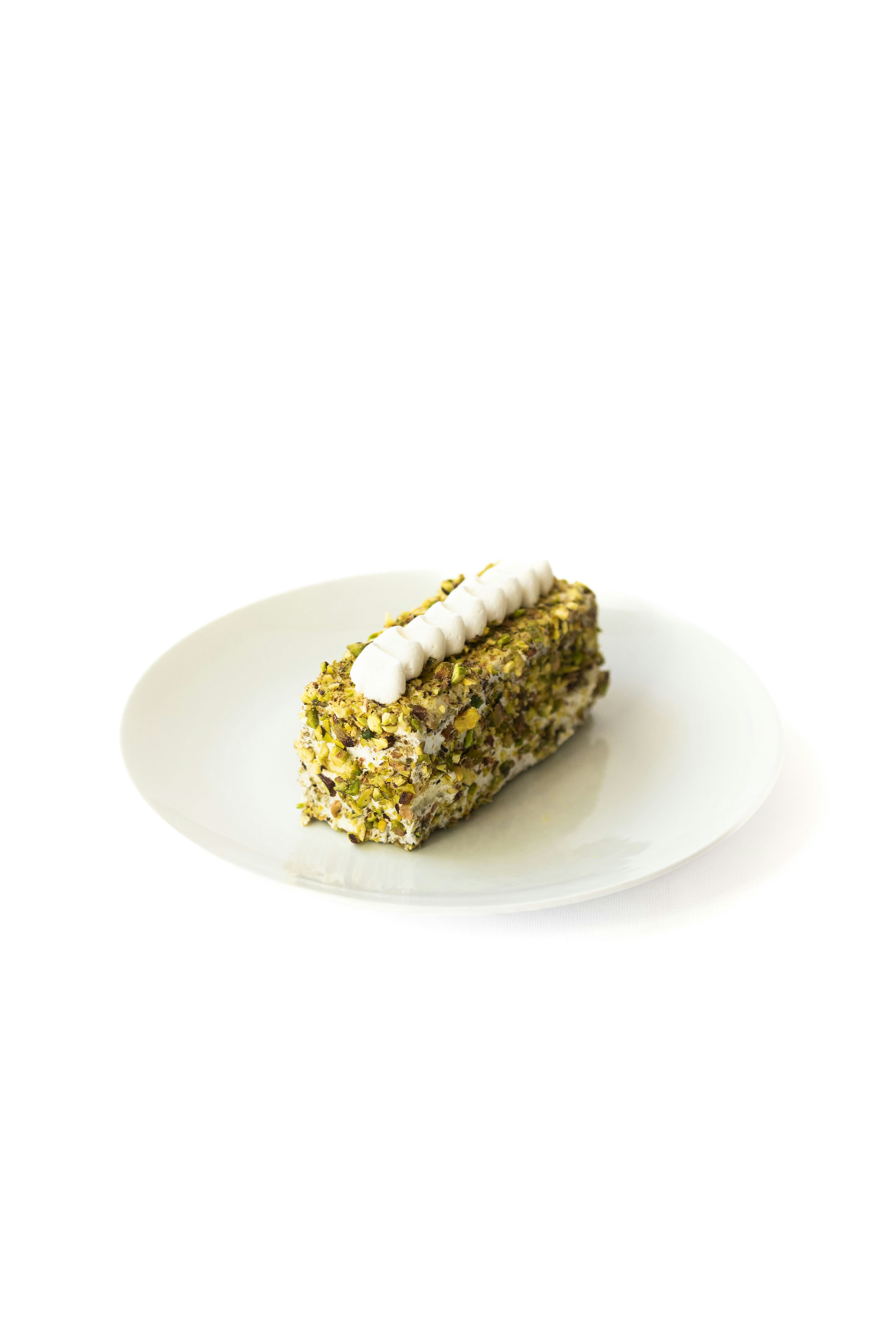 Hidden Pistachio Layer Cake on a White Plate