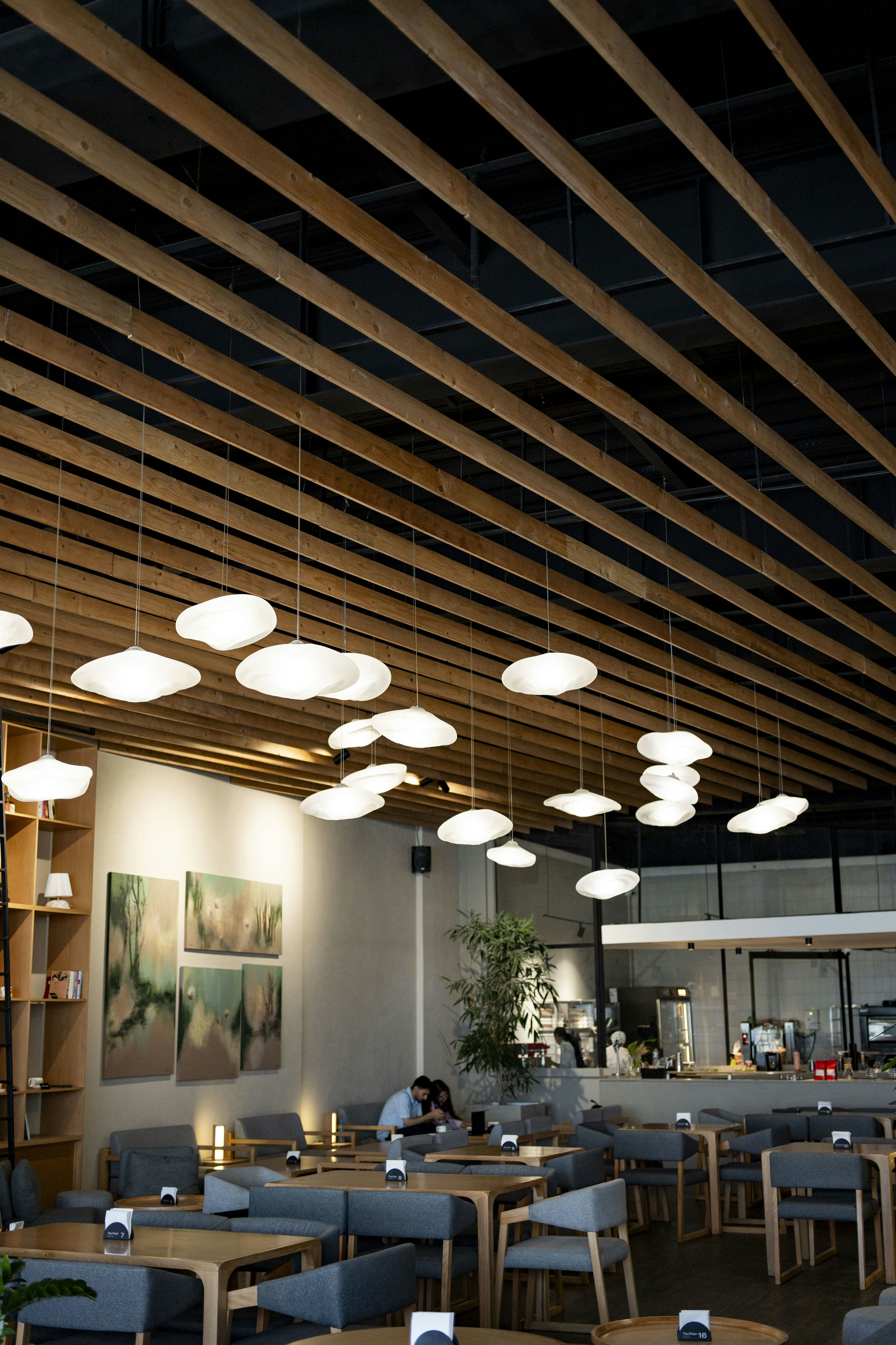 Cafe Geometry: Warm Light Beneath Wooden Slats