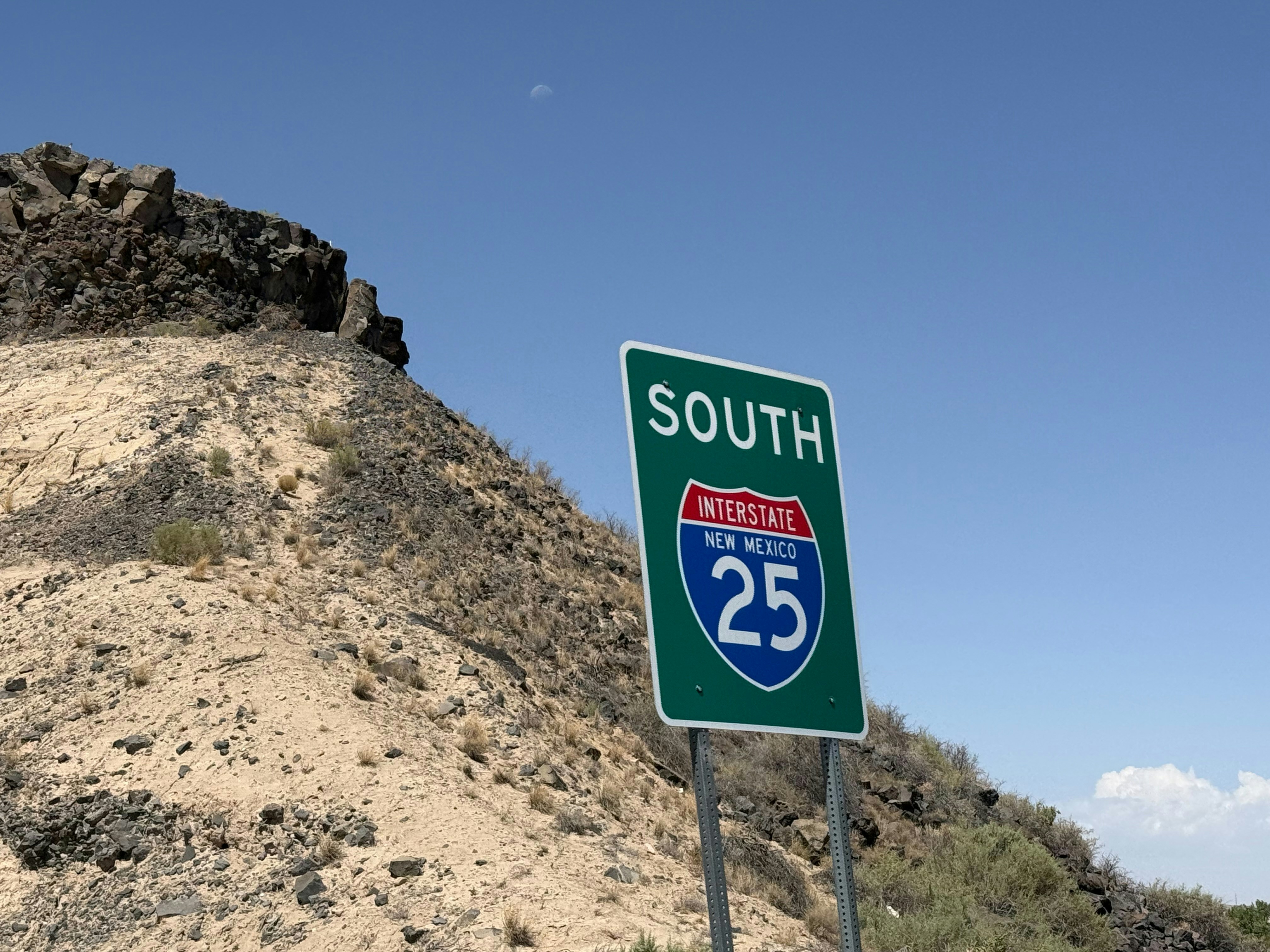 Southbound Signs and Desert Slope: Highway 25