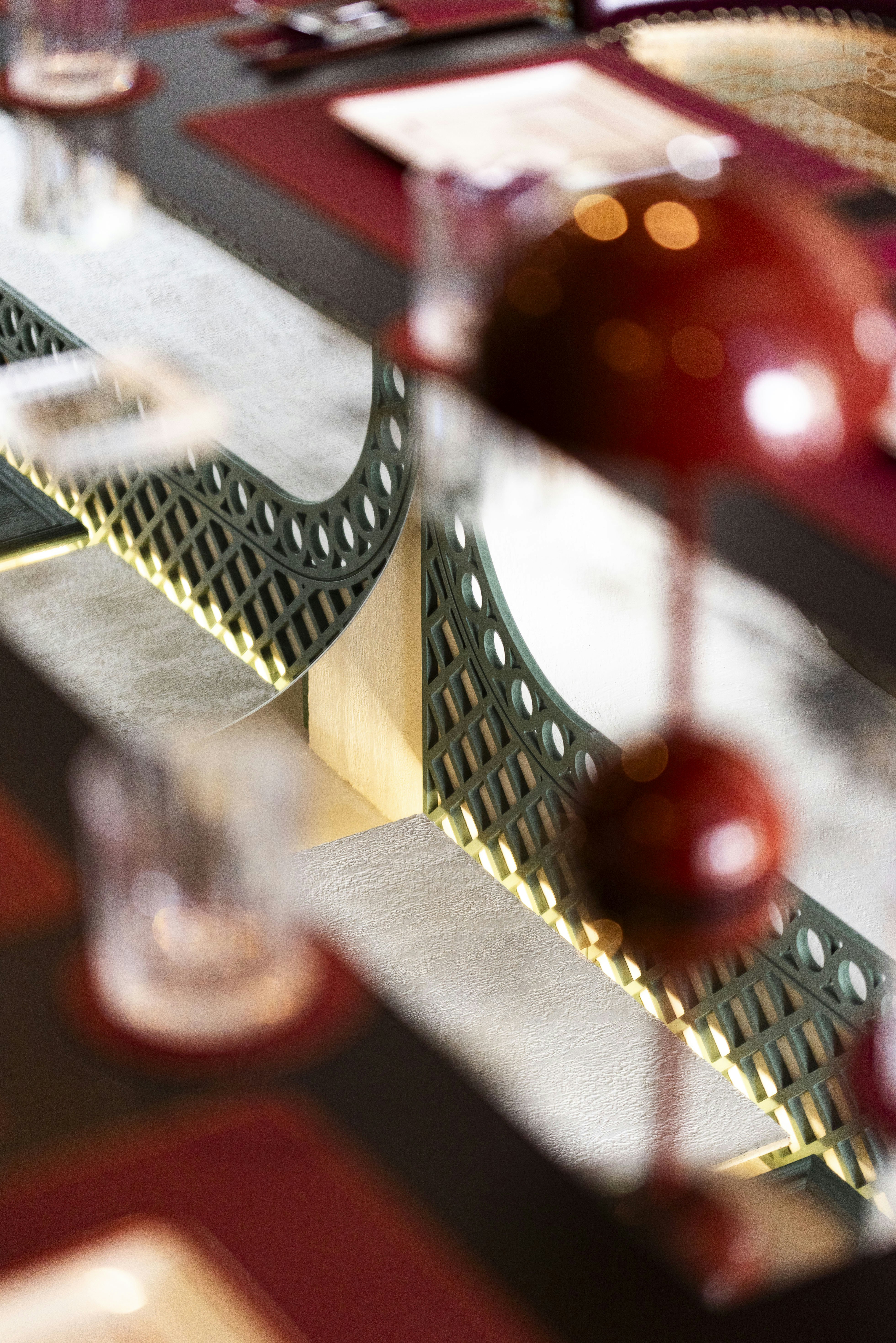 Red Glass Orbs and Geometric Railings: Abstract Still Life in Soft Focus