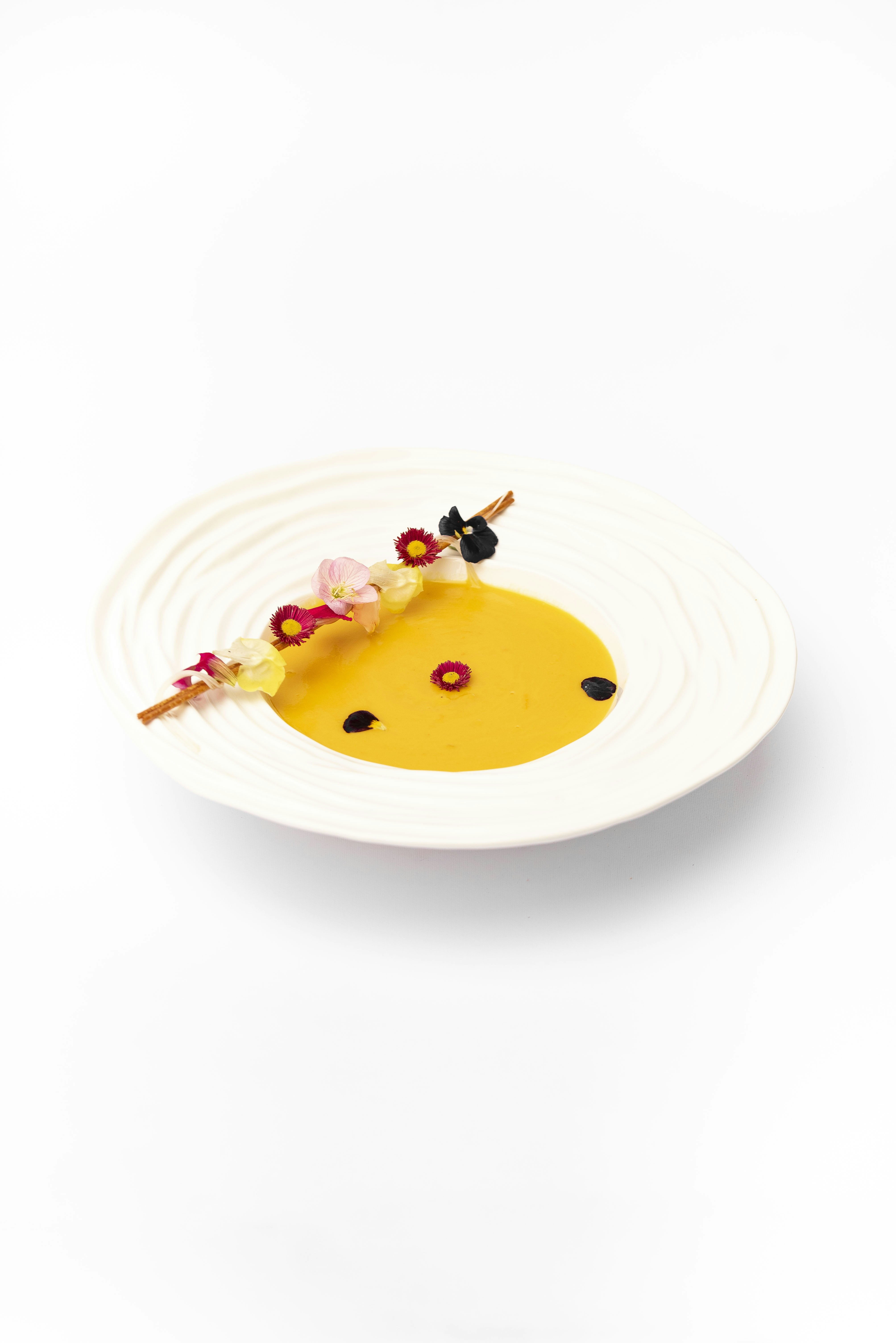 Golden Soup Symphony with Floral Skewers