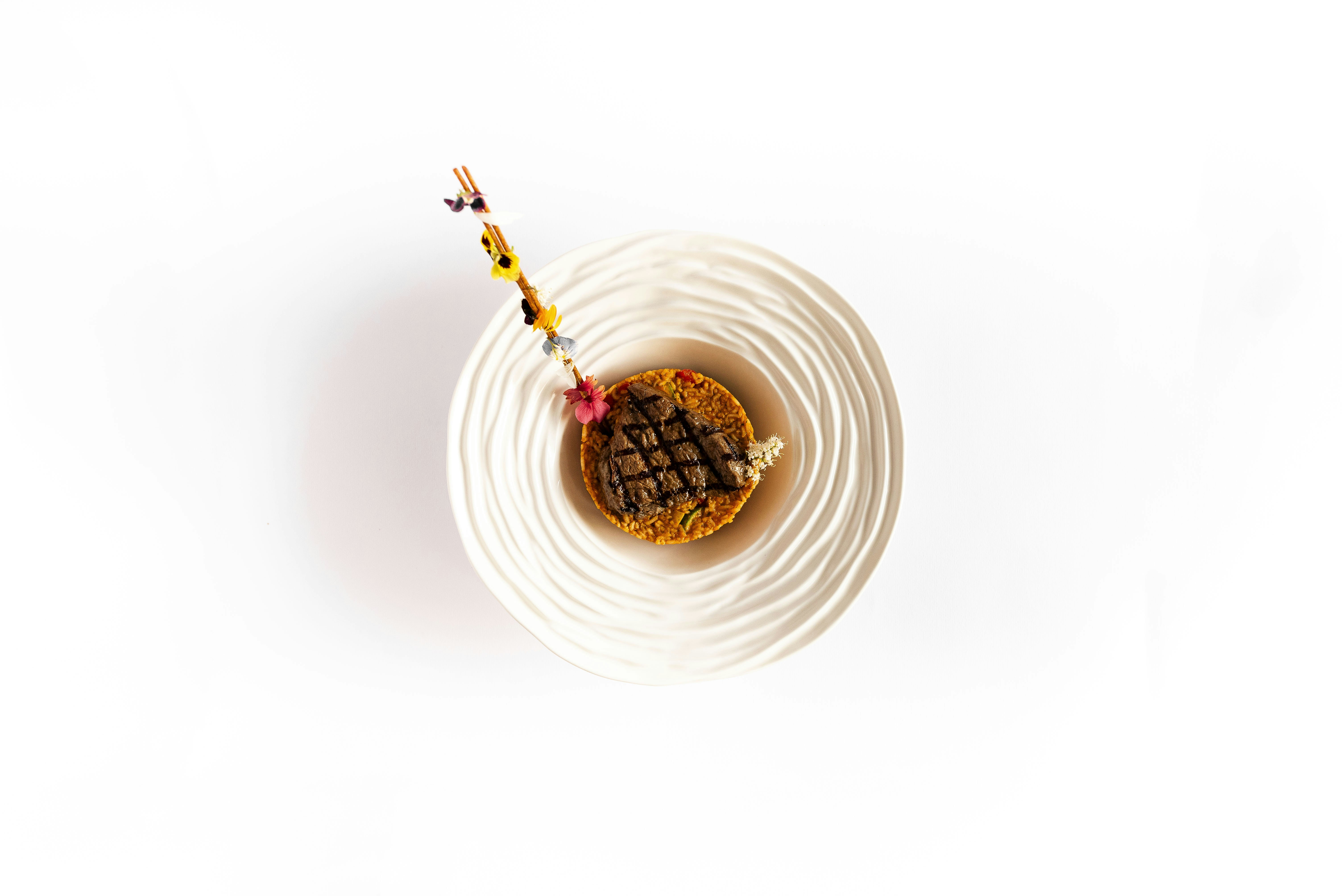 Minimalist Dessert Ring: A single bite of caramel and chocolate on a pristine white canvas