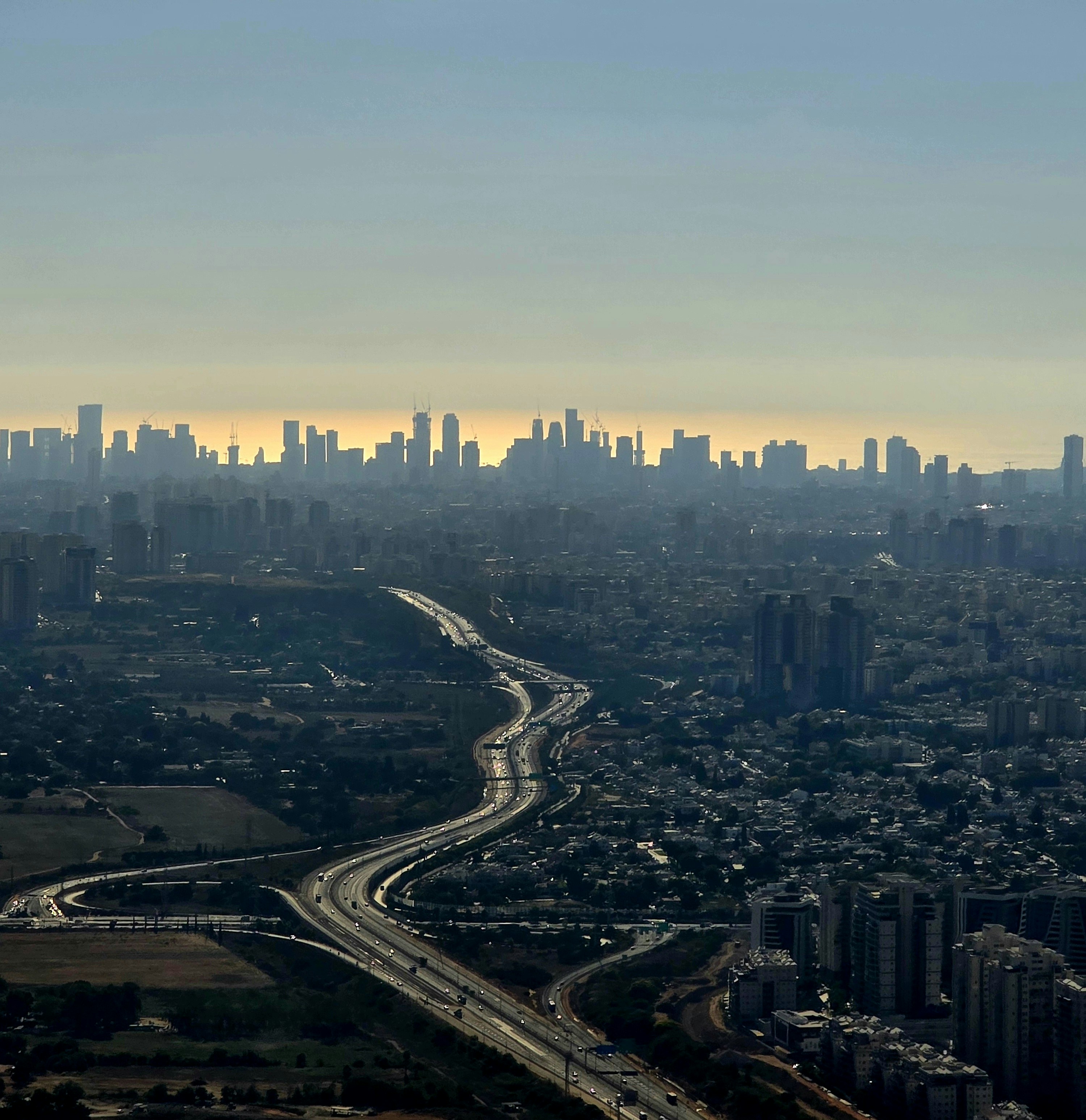 Sunlit Skyline Ribbons: A Highway Through the City